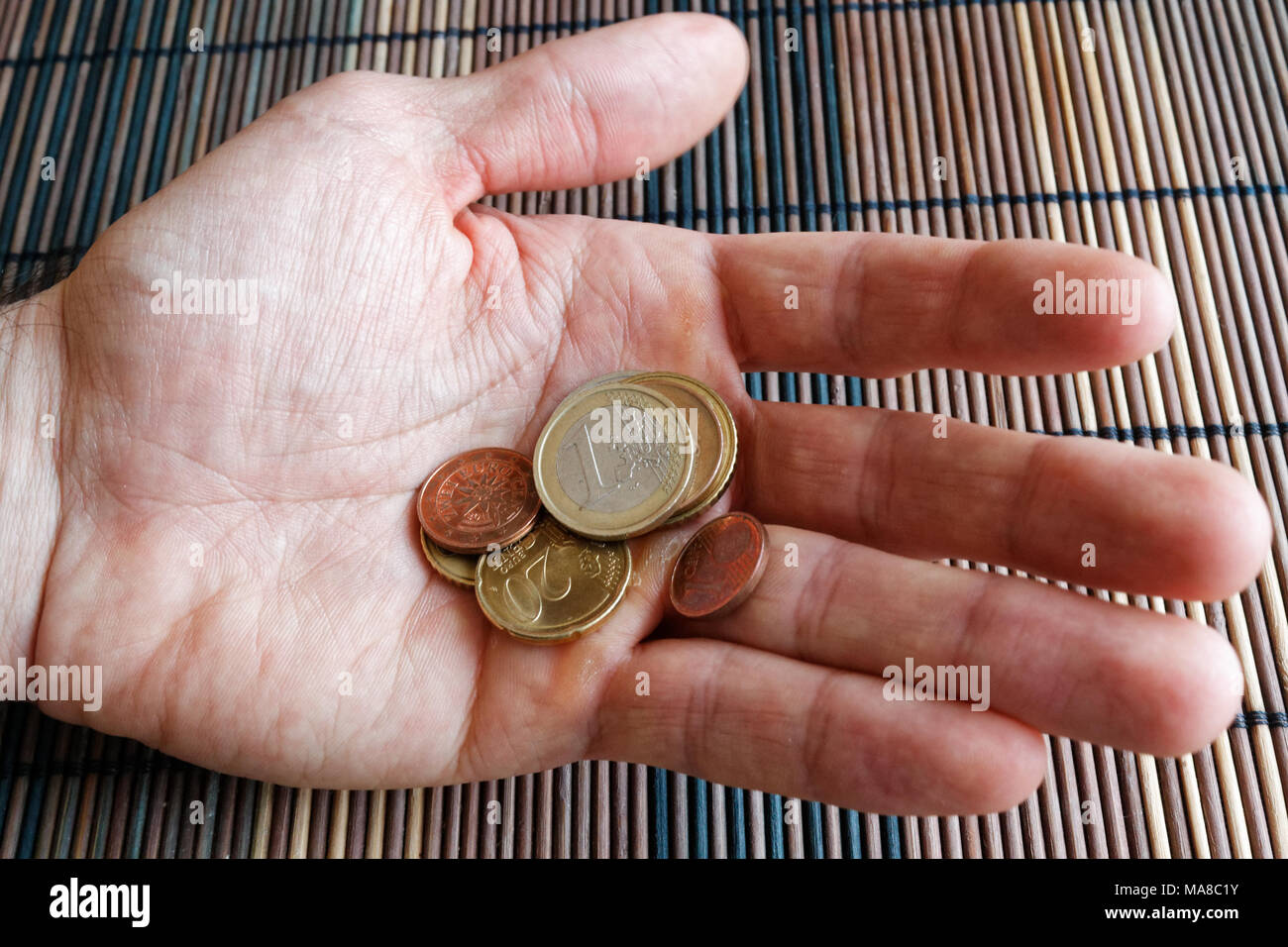 Pile of euro coins on human (man) hand Stock Photo - Alamy