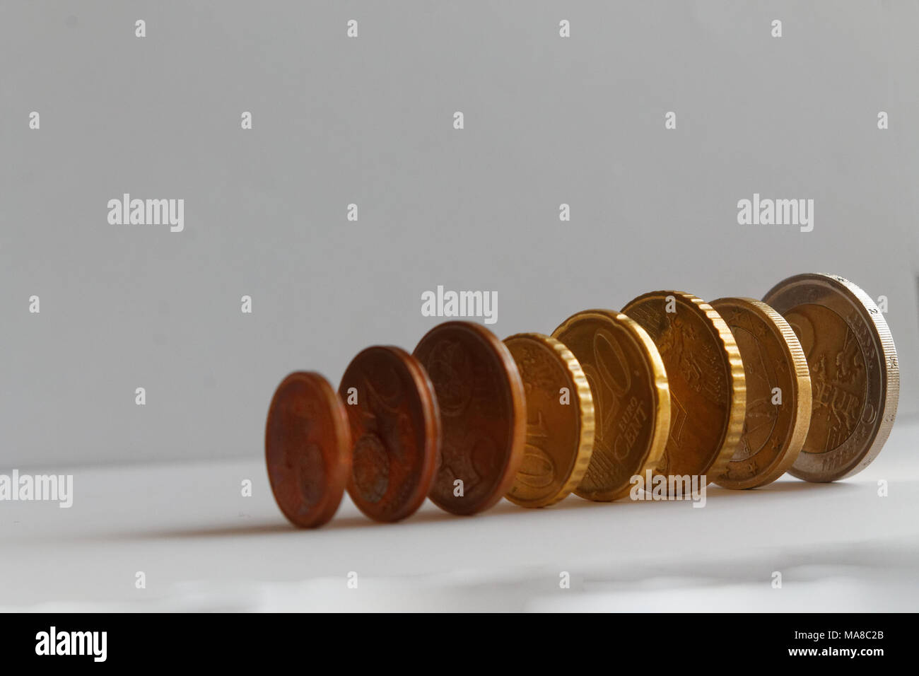 Stack of euro coins in a row on isolated white background Stock Photo ...