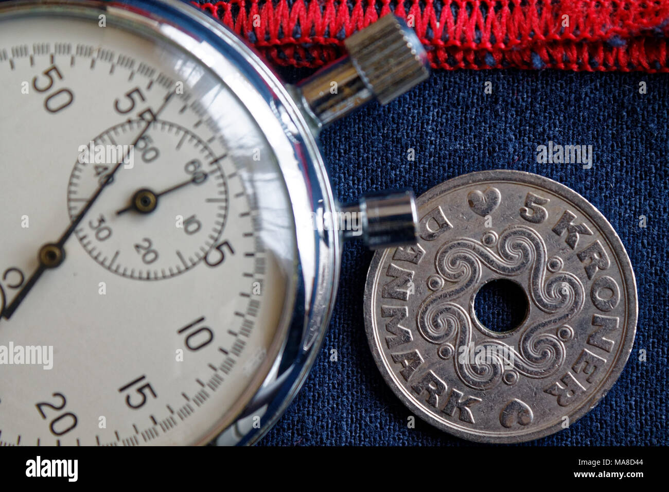 Denmark coin with a denomination of five krone (crown) and stopwatch on ...