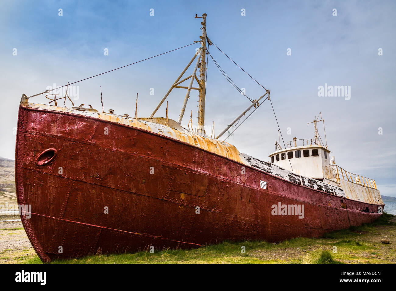 Oldest steel ship in Iceland abandoned rusty ashore in the grass, West ...