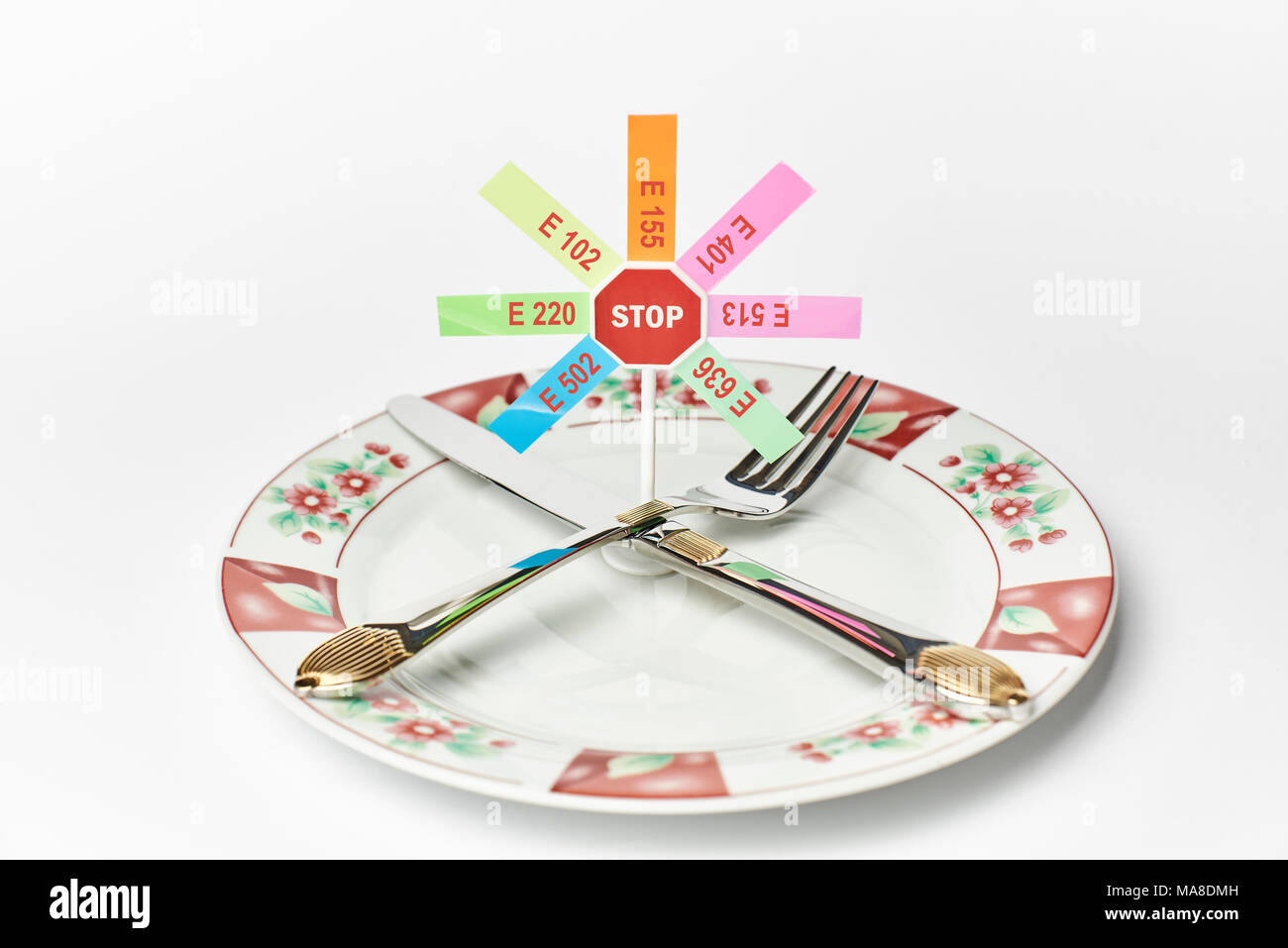 Cutlery and stop sign with banned additives on white background Stock ...