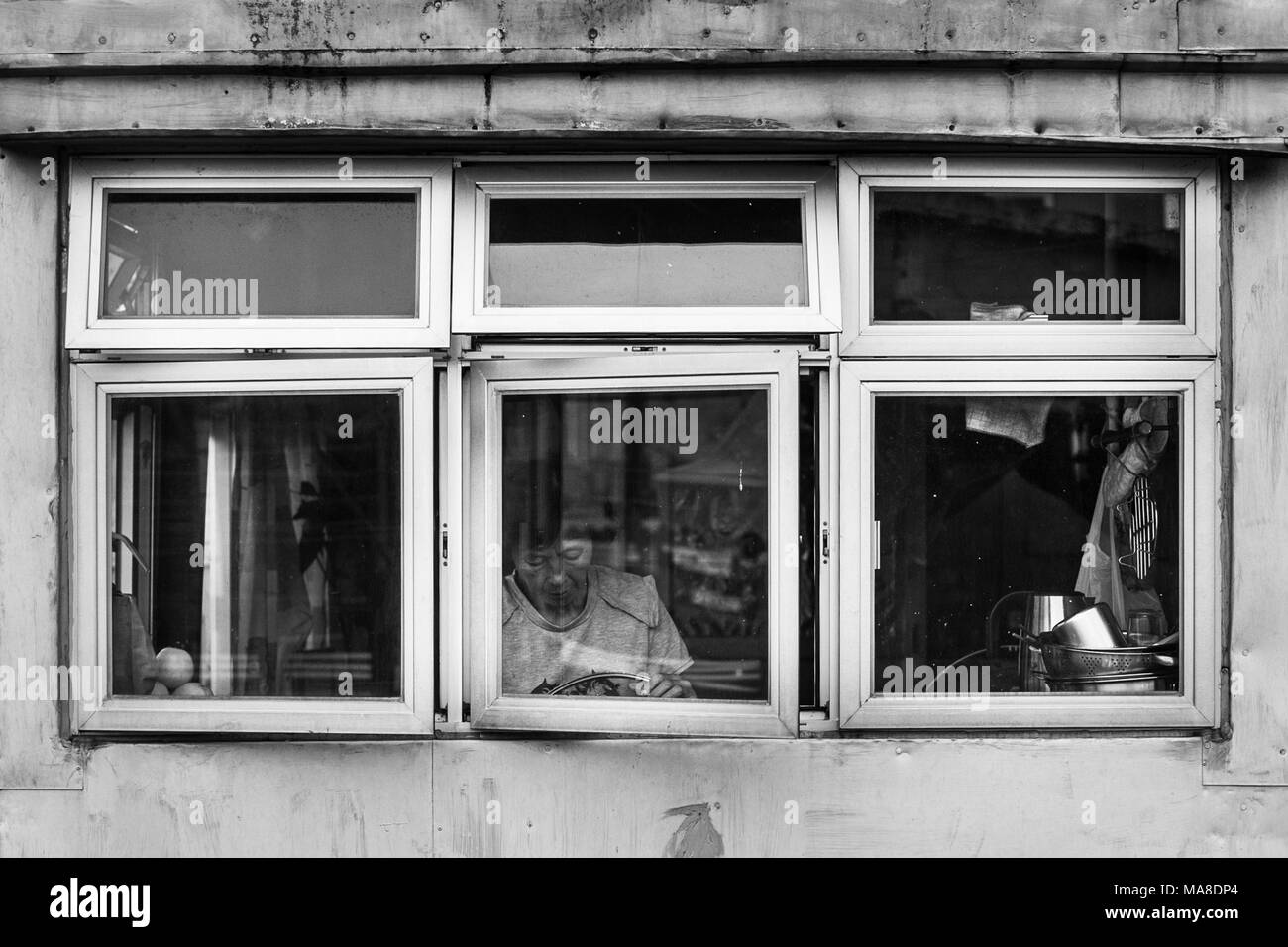 A woman stands at a kitchen window Stock Photo - Alamy