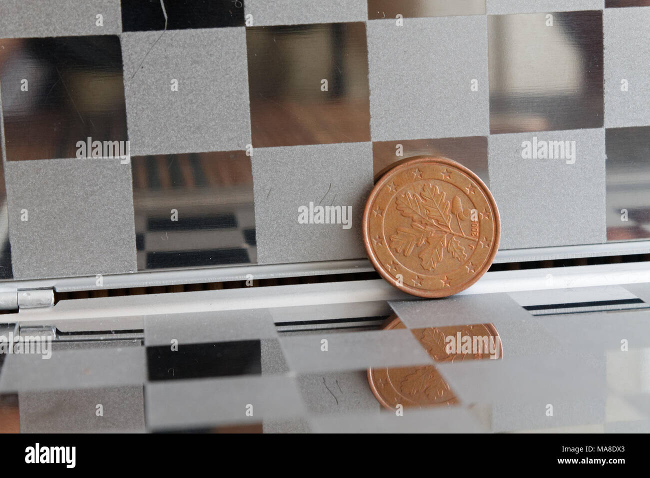 Euro coins in mirror reflect lies in chequered wallet, background ...