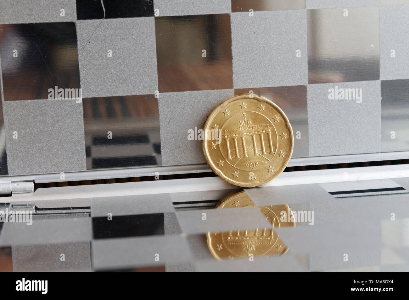 Euro coins in mirror reflect lies in chequered wallet, background ...