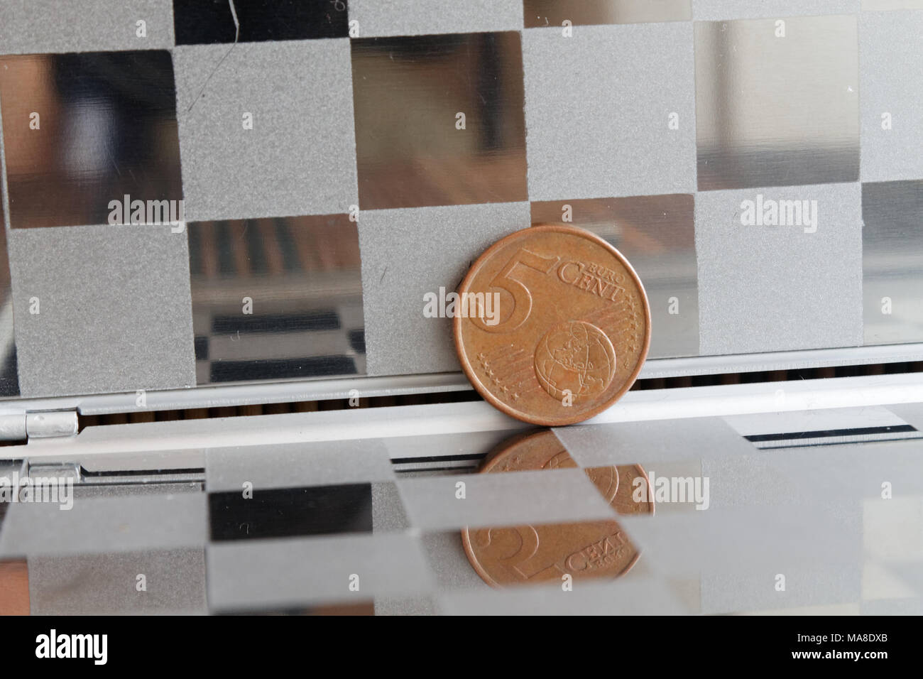 Euro coins in mirror reflect lies in chequered wallet, background ...