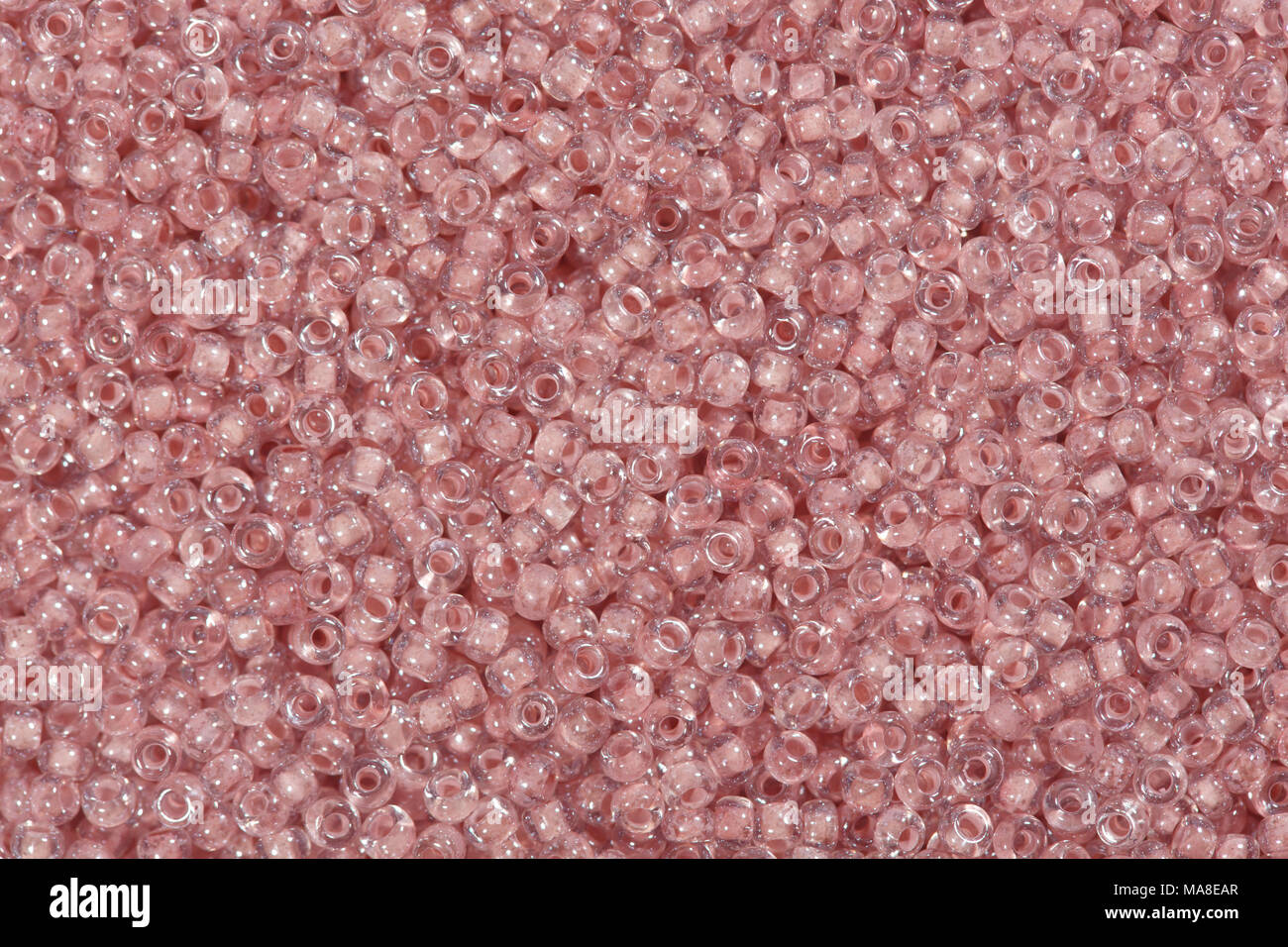 Violet seed beads background Stock Photo - Alamy