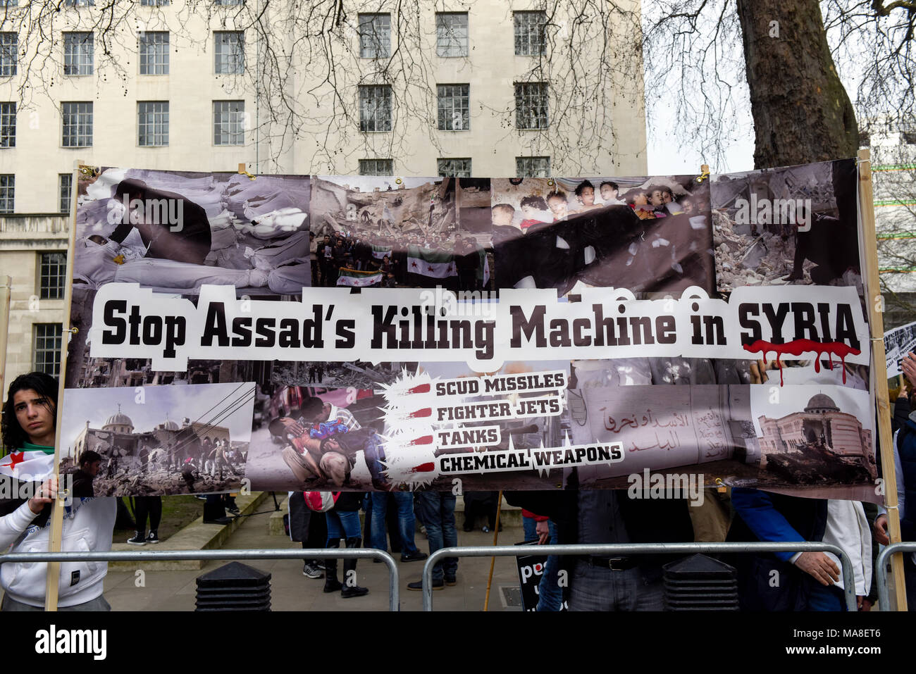 People holding a placard: "Stop Assad's Killing Machine in Syria ...