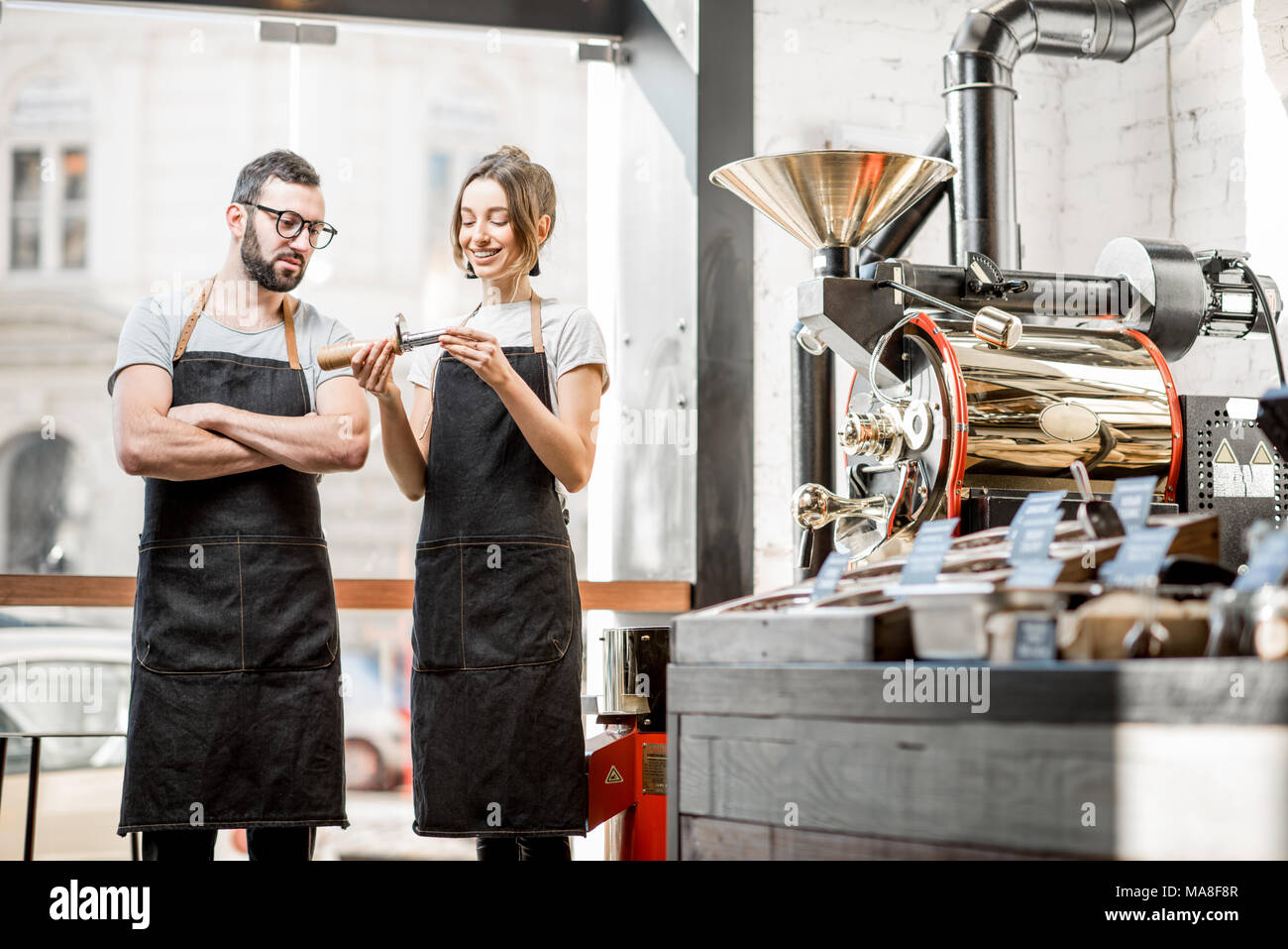 Couple baristas in uniform checking hi-res stock photography and images ...