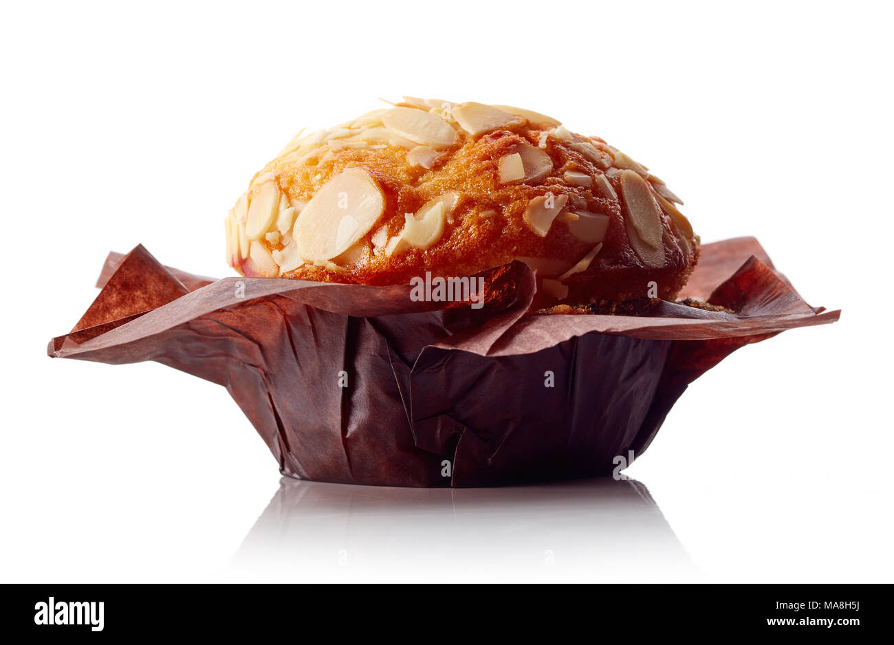 Almond muffin in brown paper isolated on white background Stock Photo ...
