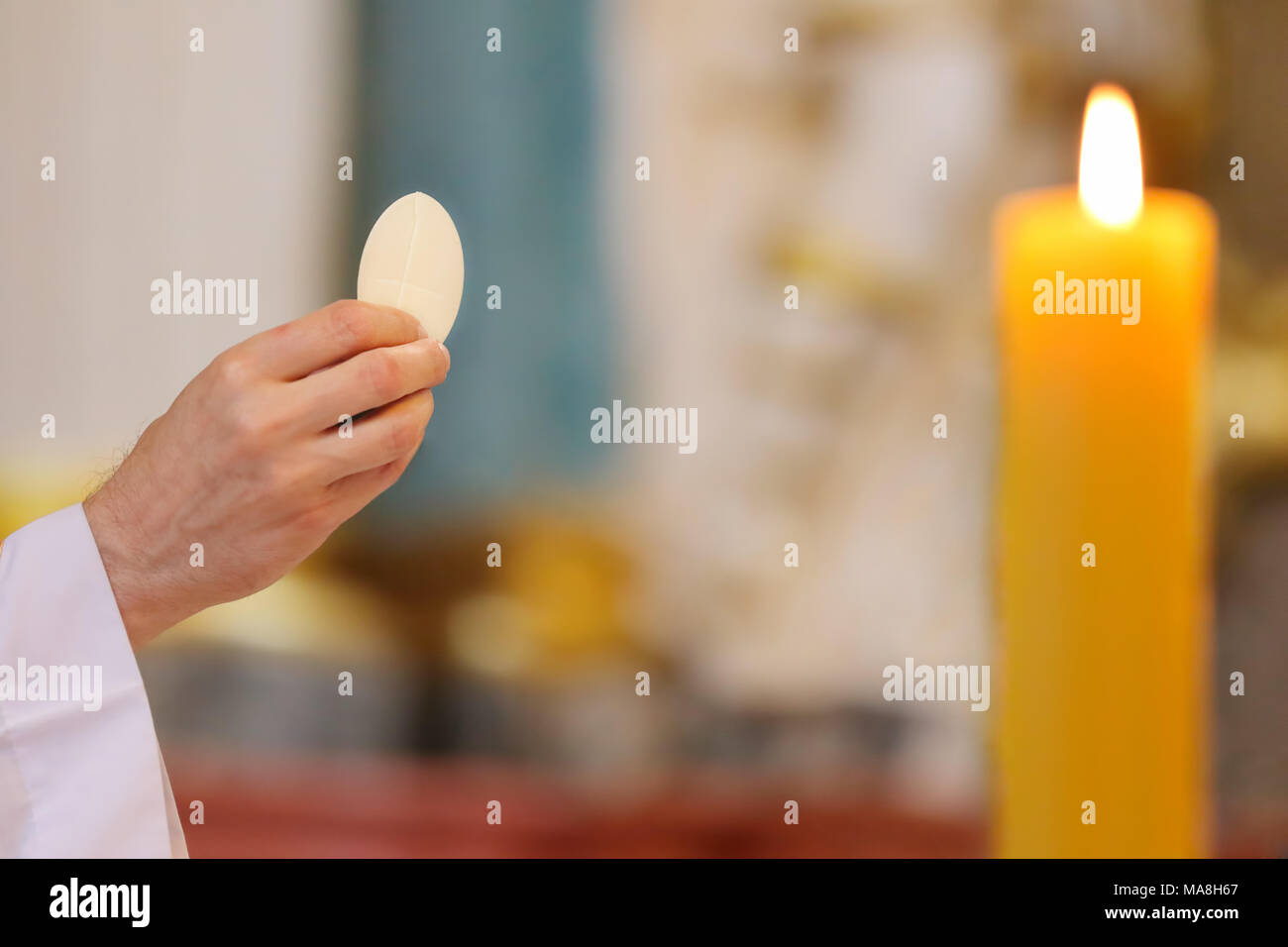 Priest gives holy communion to faithful and empty place for text Stock ...