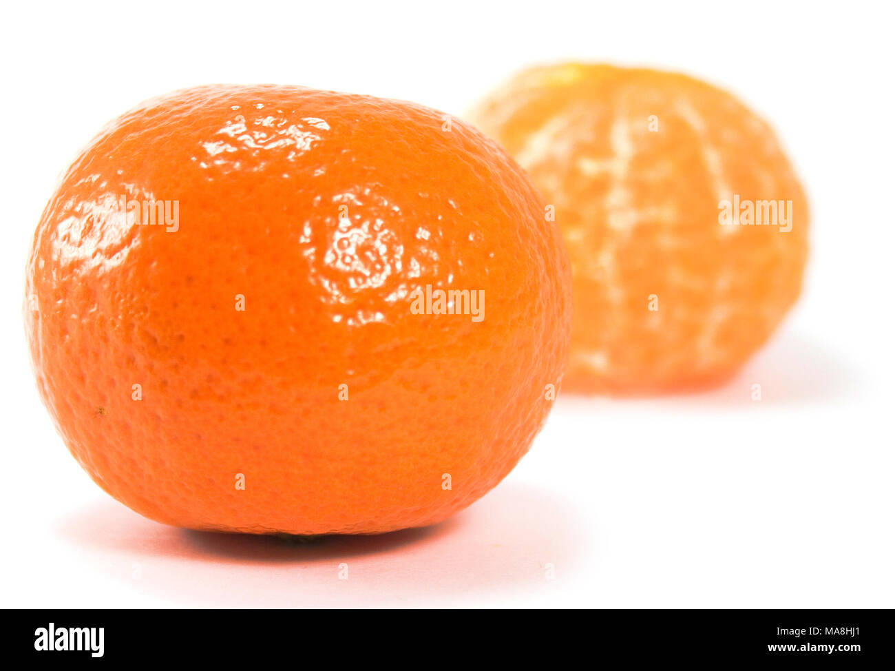 two tangerines over white background Stock Photo - Alamy