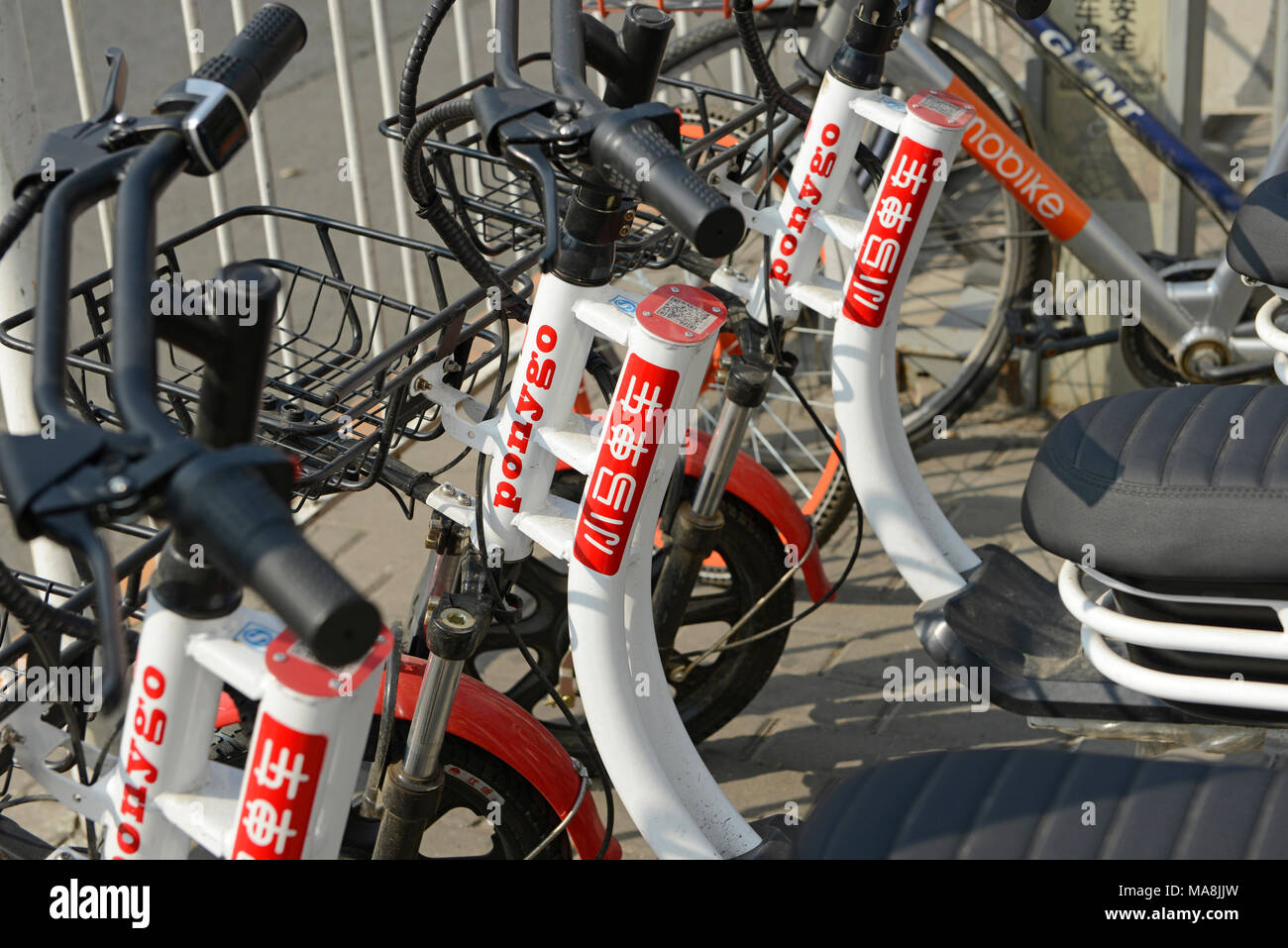 Dockless electric bicycles for rent parked by an intersection on the ...