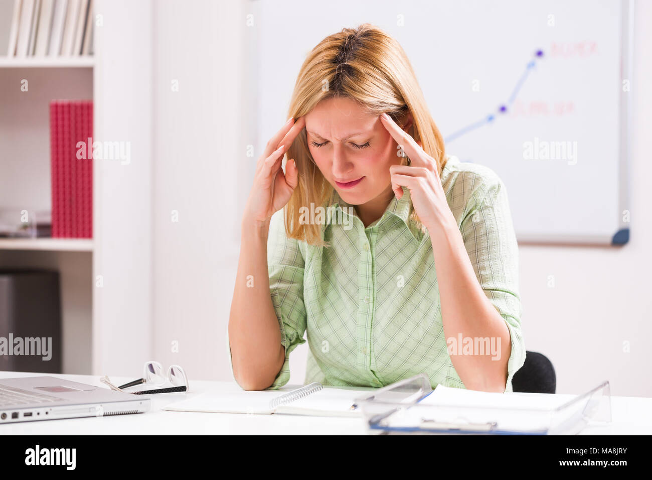 Businesswoman is having headache at work Stock Photo - Alamy