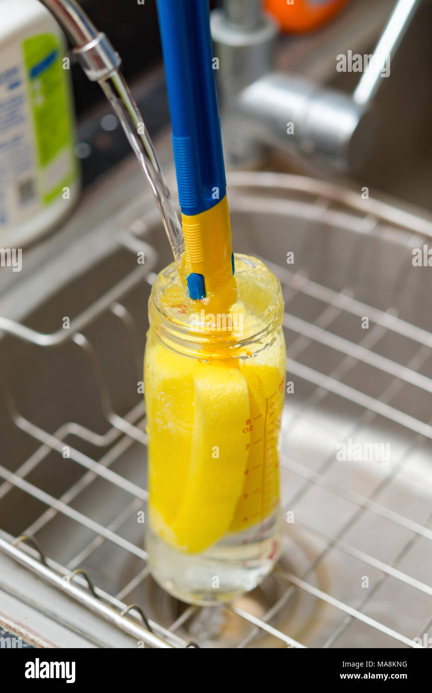washing baby milk bottle above a sink Stock Photo - Alamy