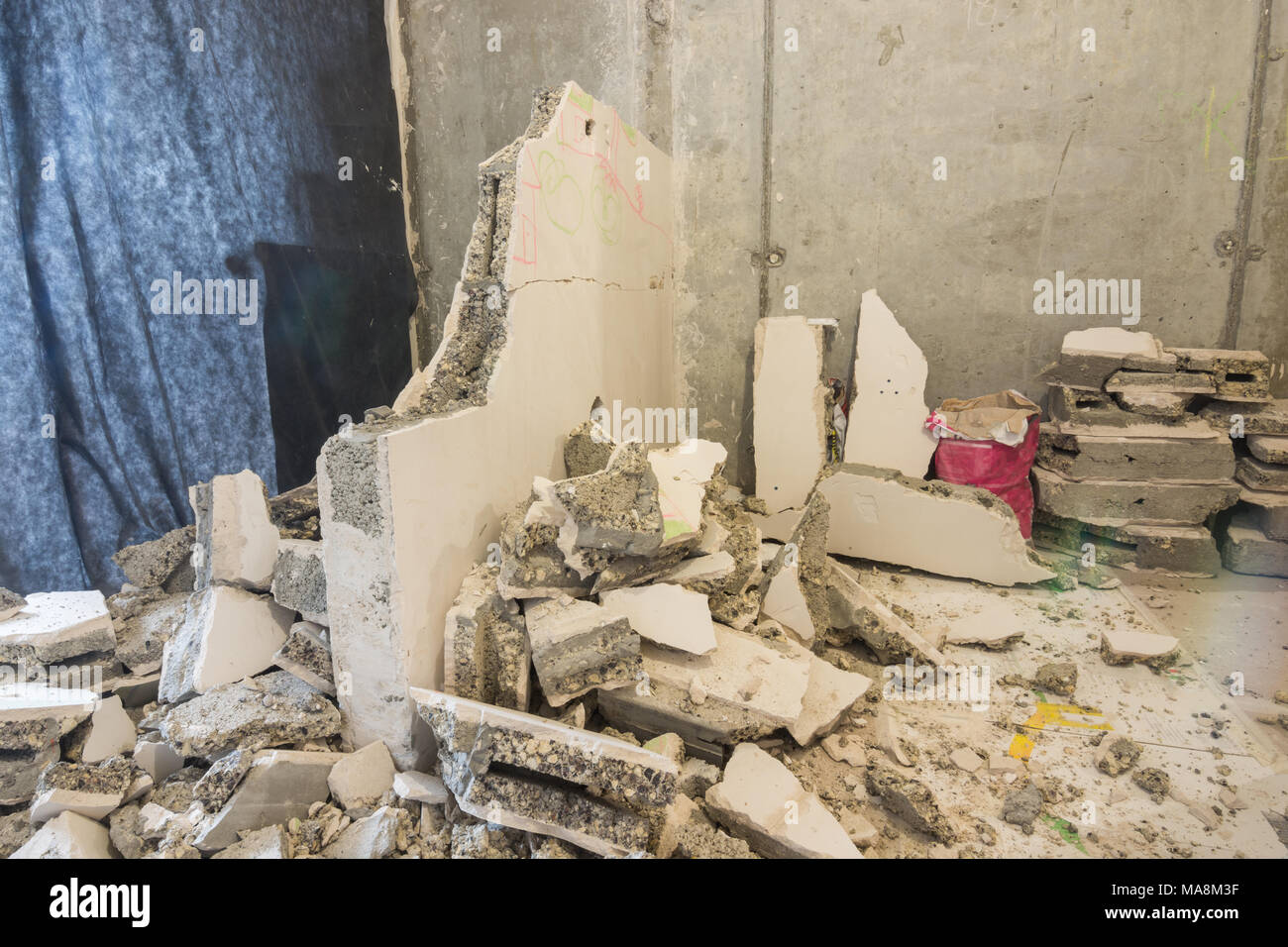 Broken parts of the wall lie around the wall being dismantled Stock ...