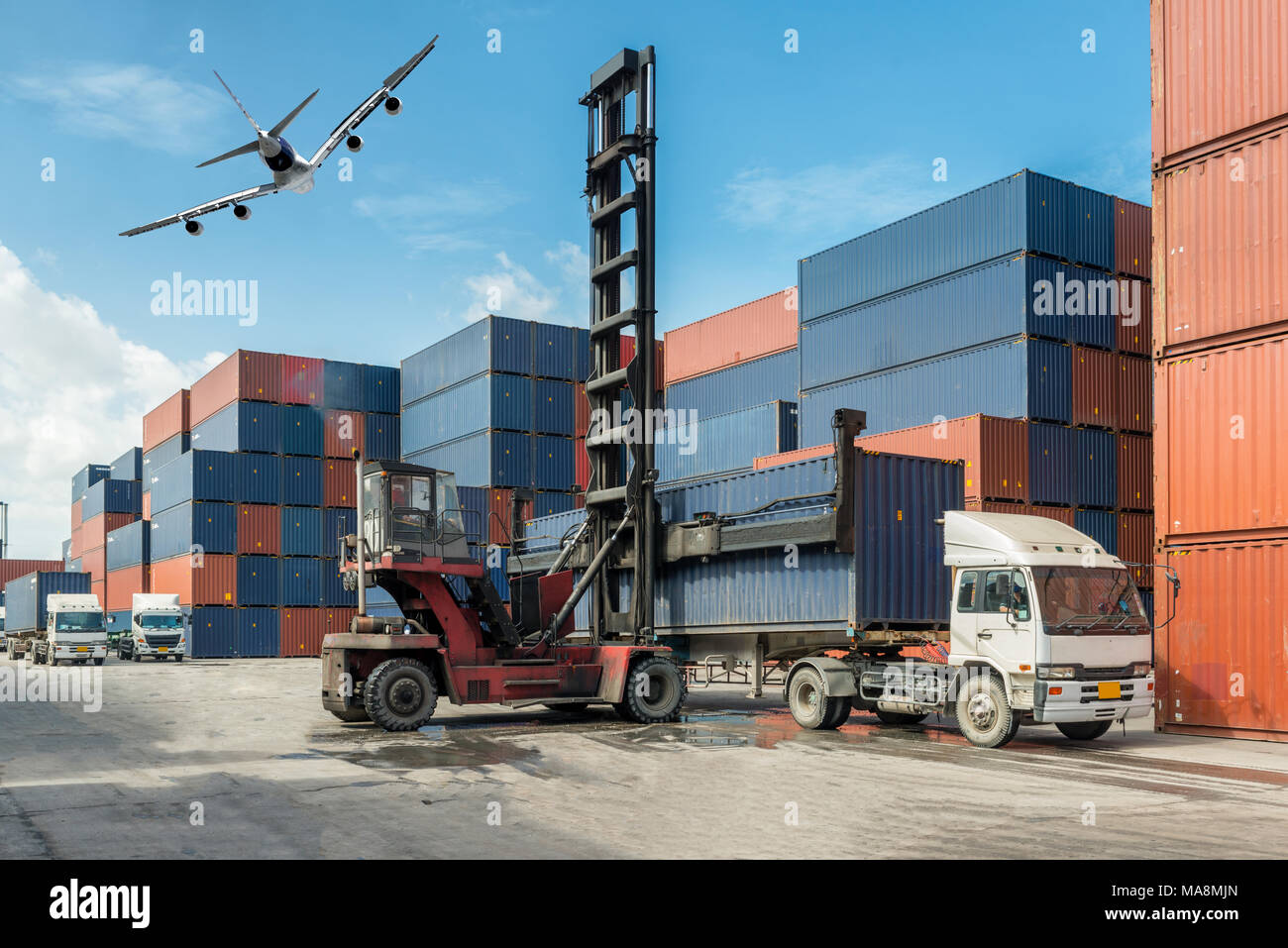 Forklift handling container box loading at docks with truck for ...