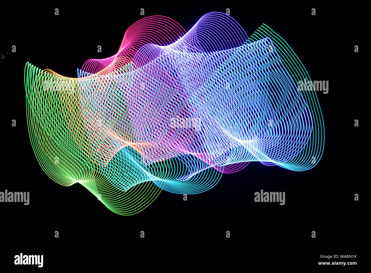 Multi color abstract light painting. LED lights on black background ...