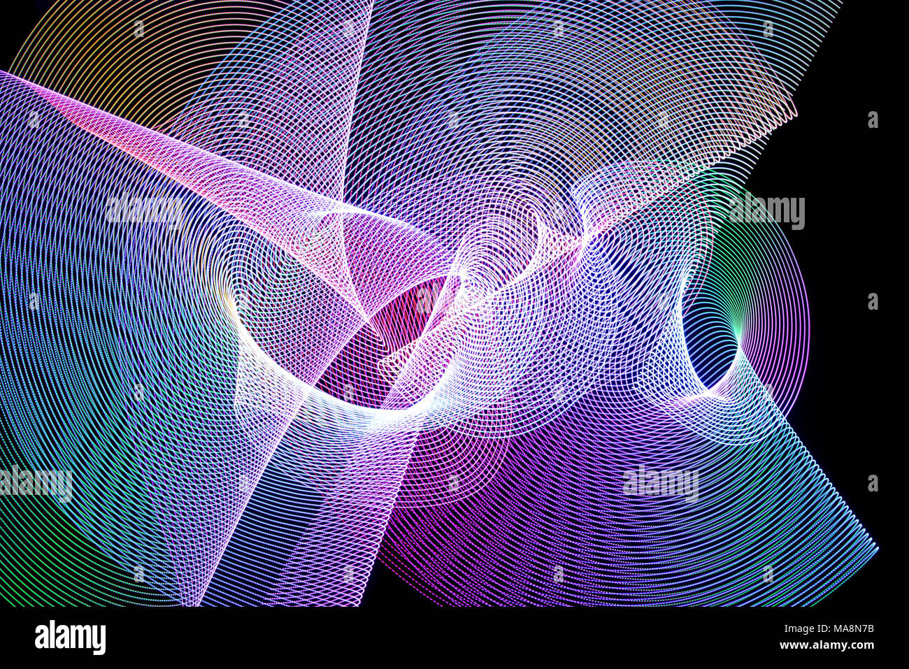 Multi color abstract light painting. LED lights on black background ...