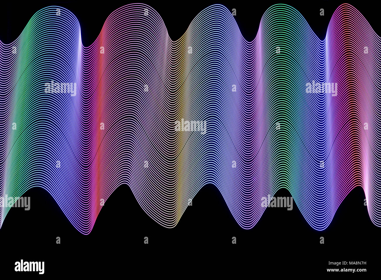 Multi color abstract light painting. LED lights on black background ...