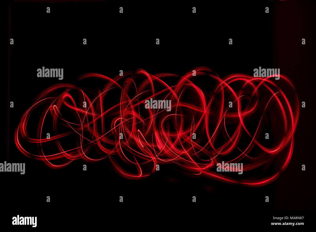 Red color abstract light painting. LED lights on black background Stock ...