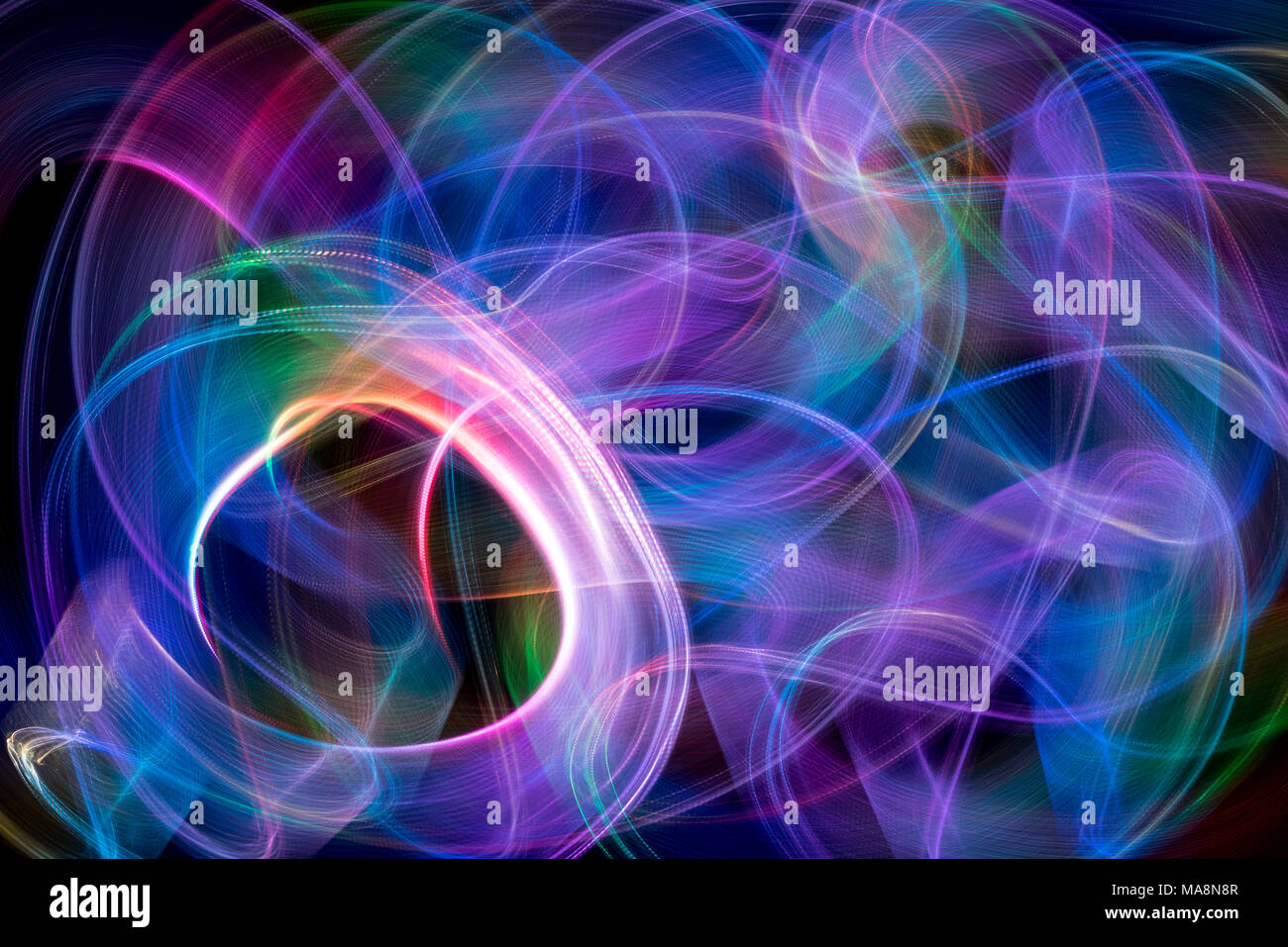 Multi color abstract light painting. LED lights on black background ...