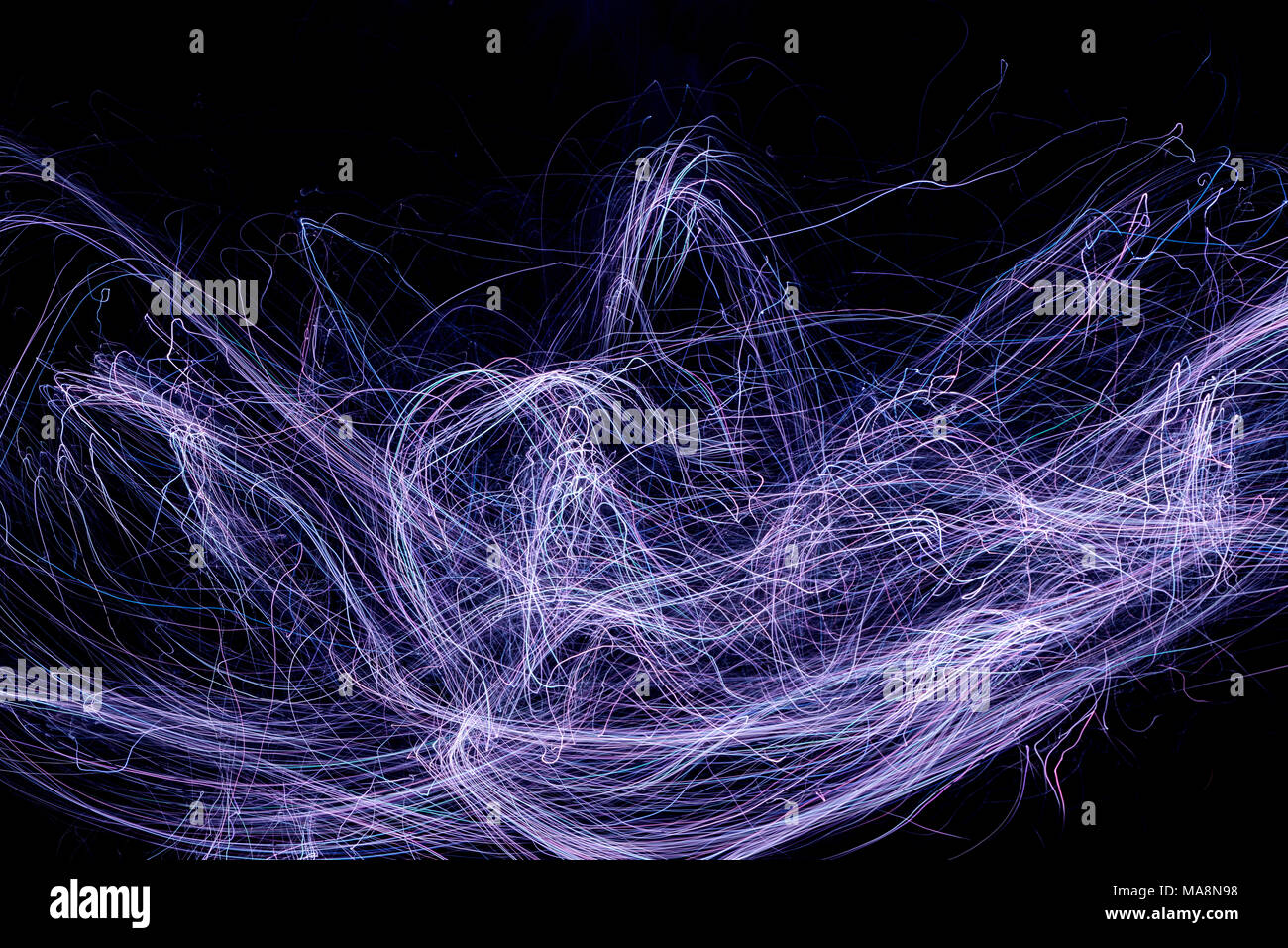 Multi color abstract light painting. LED lights on black background ...