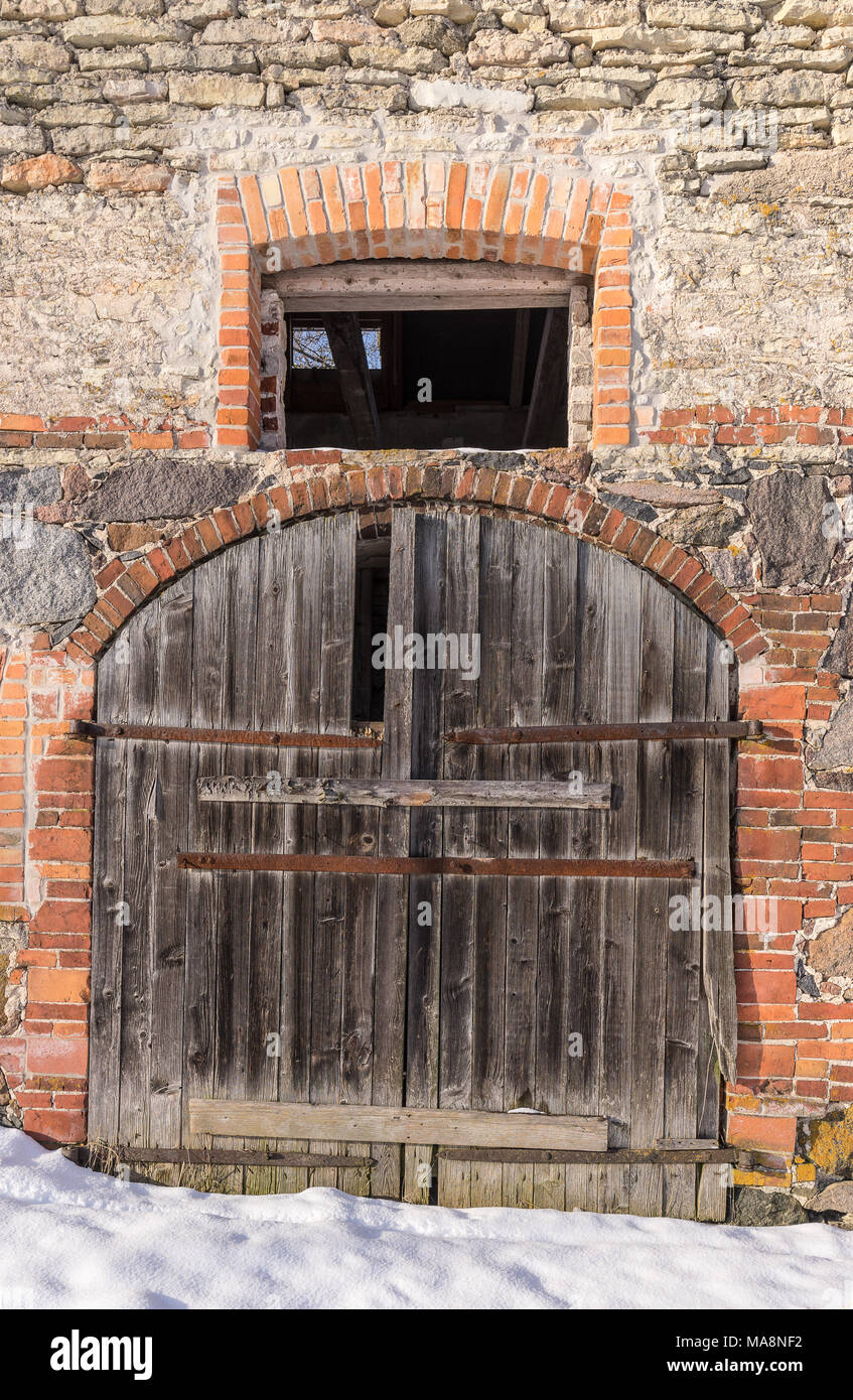 Stone wall texture and windows with red frames, natural background ...