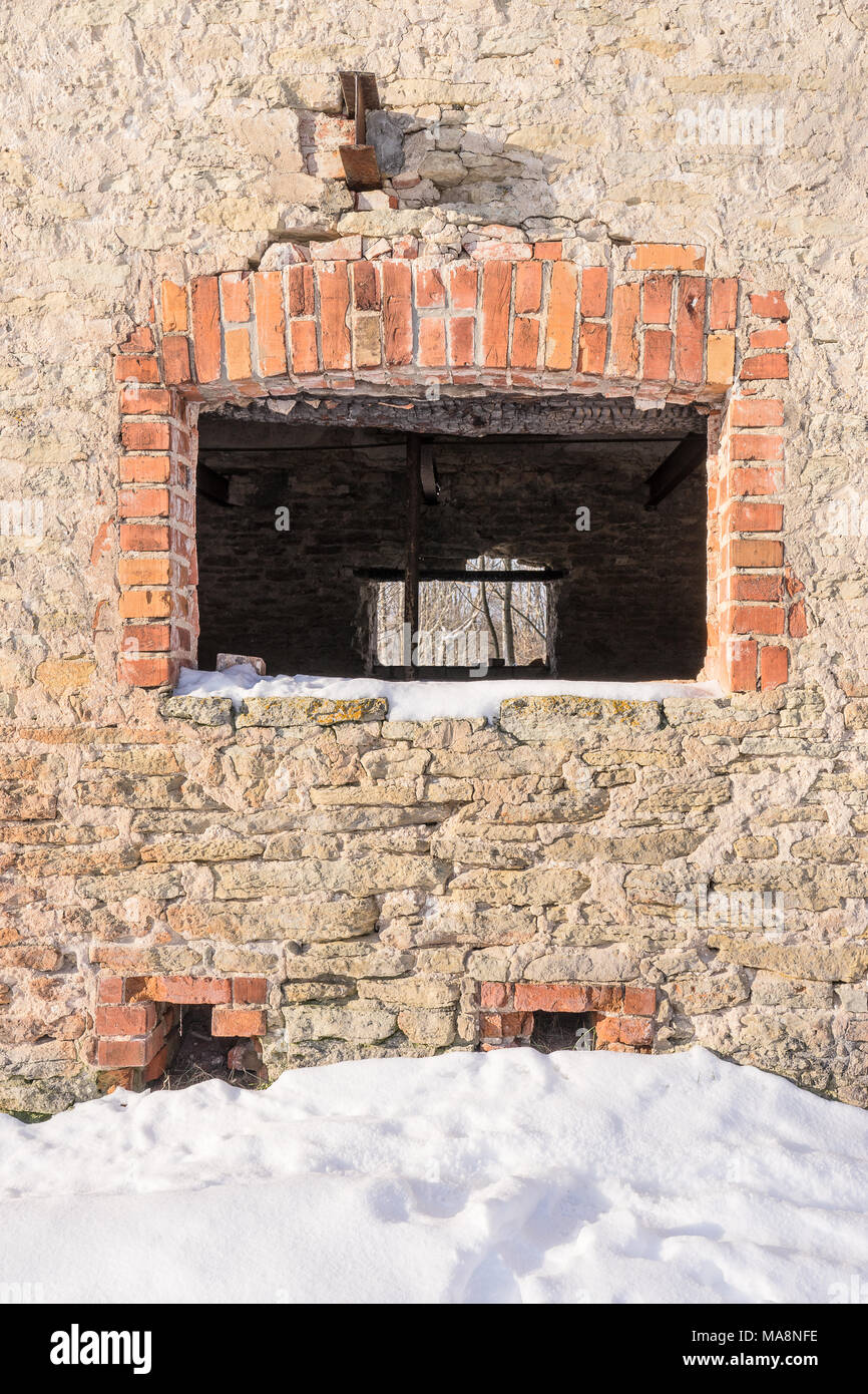 Stone wall texture and windows with red frames, natural background ...