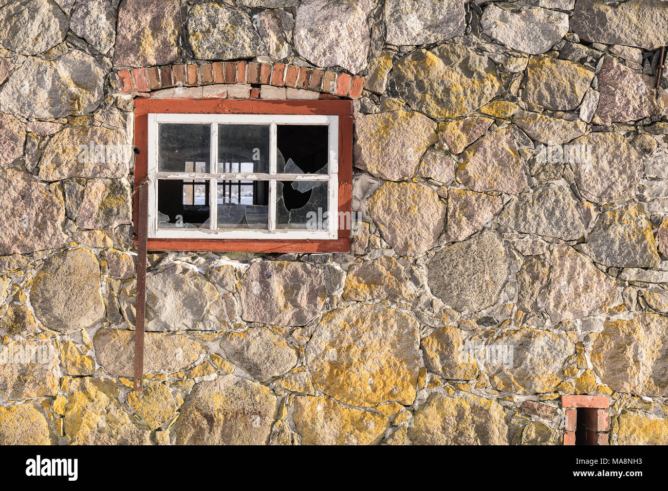 Stone wall texture and windows with red frames, natural background ...
