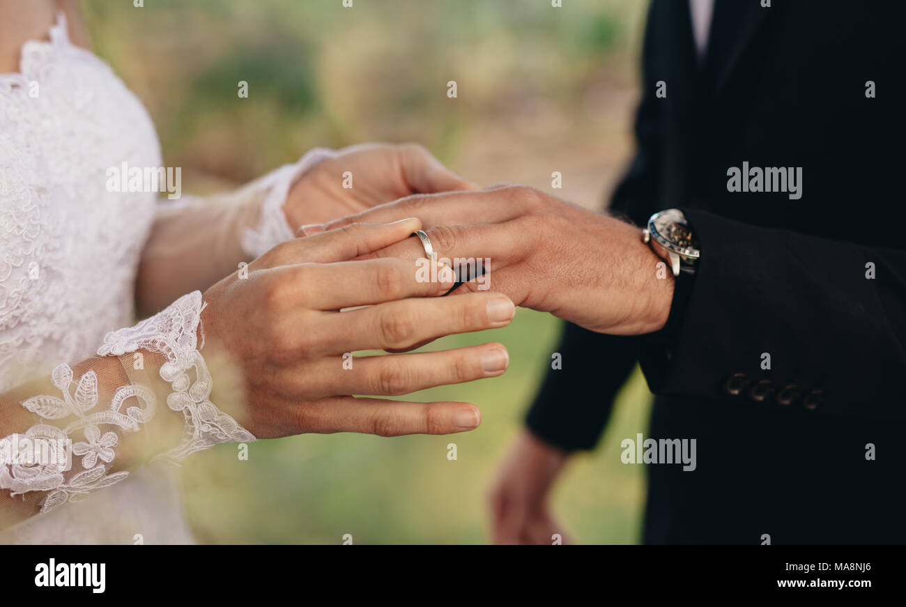 Husband wife putting wedding rings hi-res stock photography and images ...