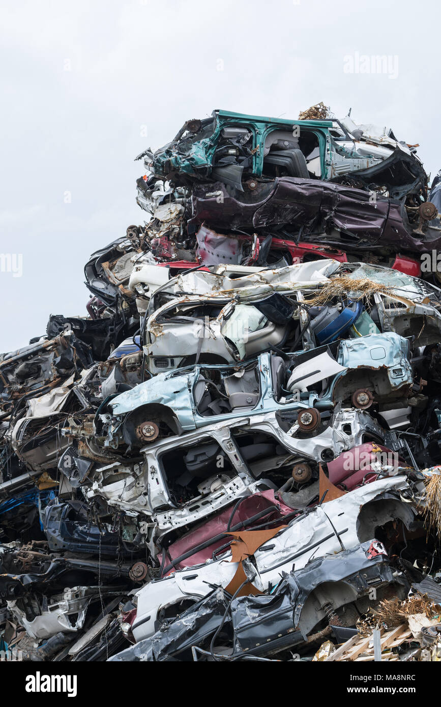 Dumping ground. Scrap metal heap. Compressed crushed cars is returned ...