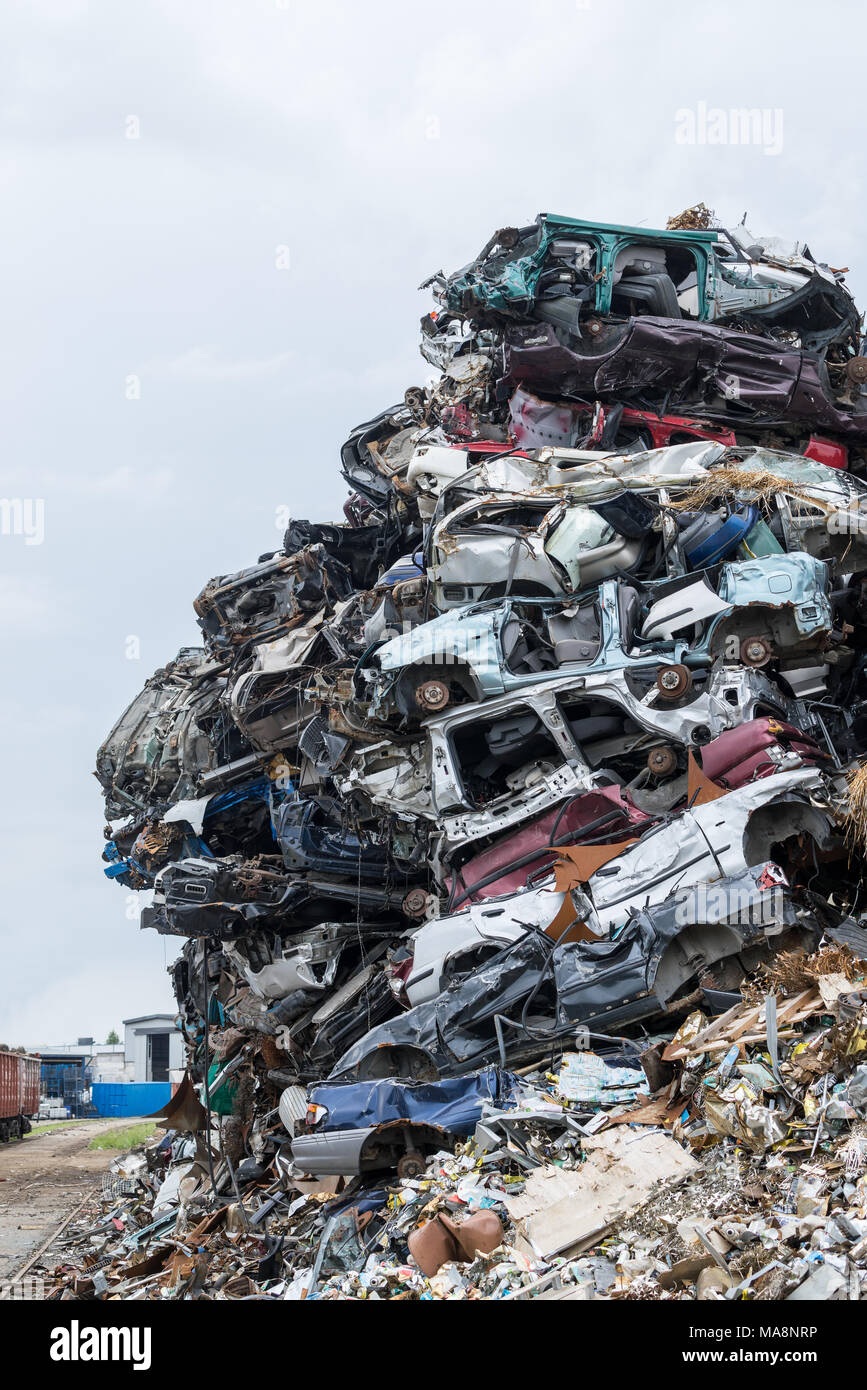 Dumping ground. Scrap metal heap. Compressed crushed cars is returned ...