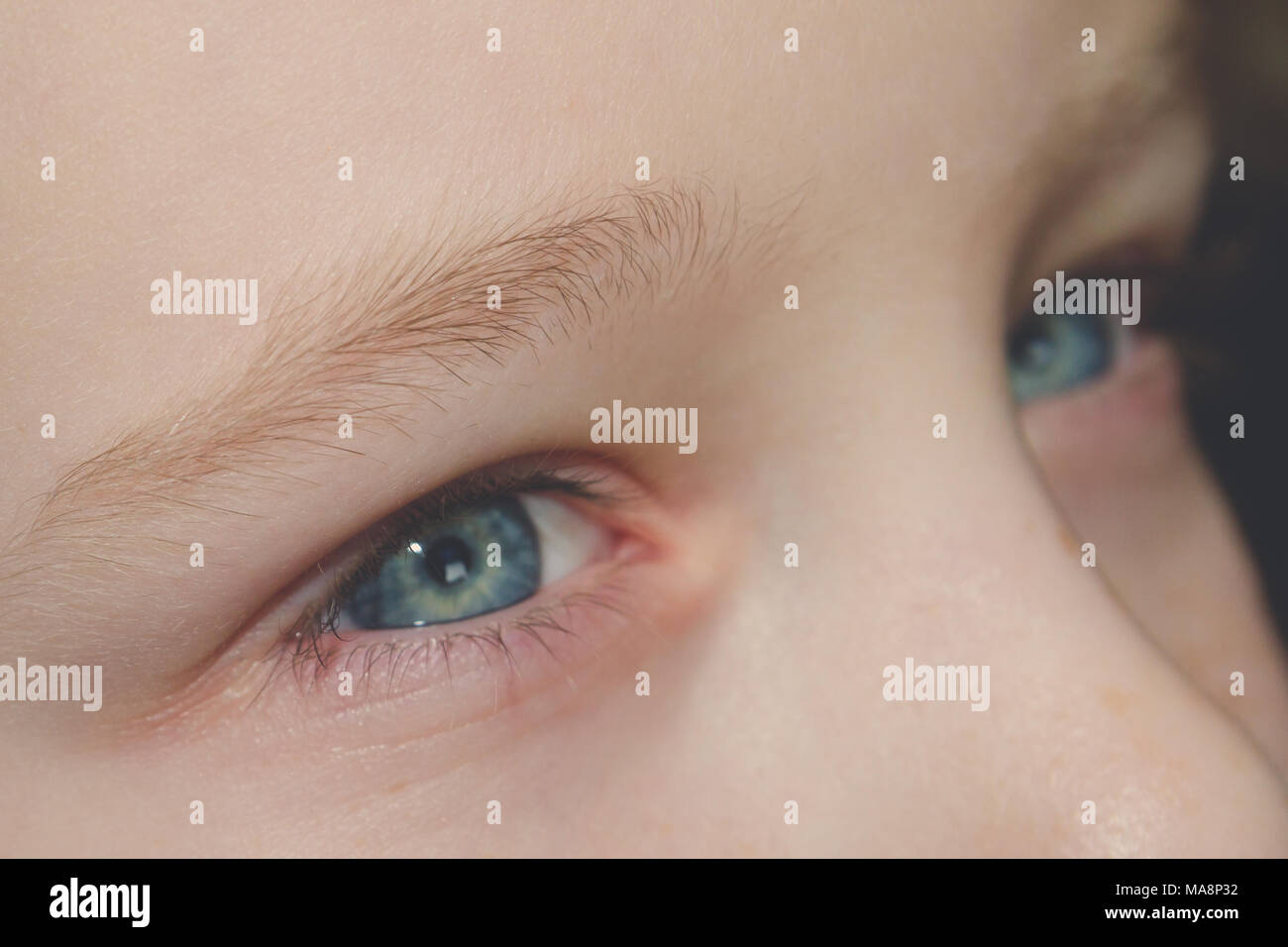 Baby blue beautiful, brooding eyes of a boy Stock Photo - Alamy