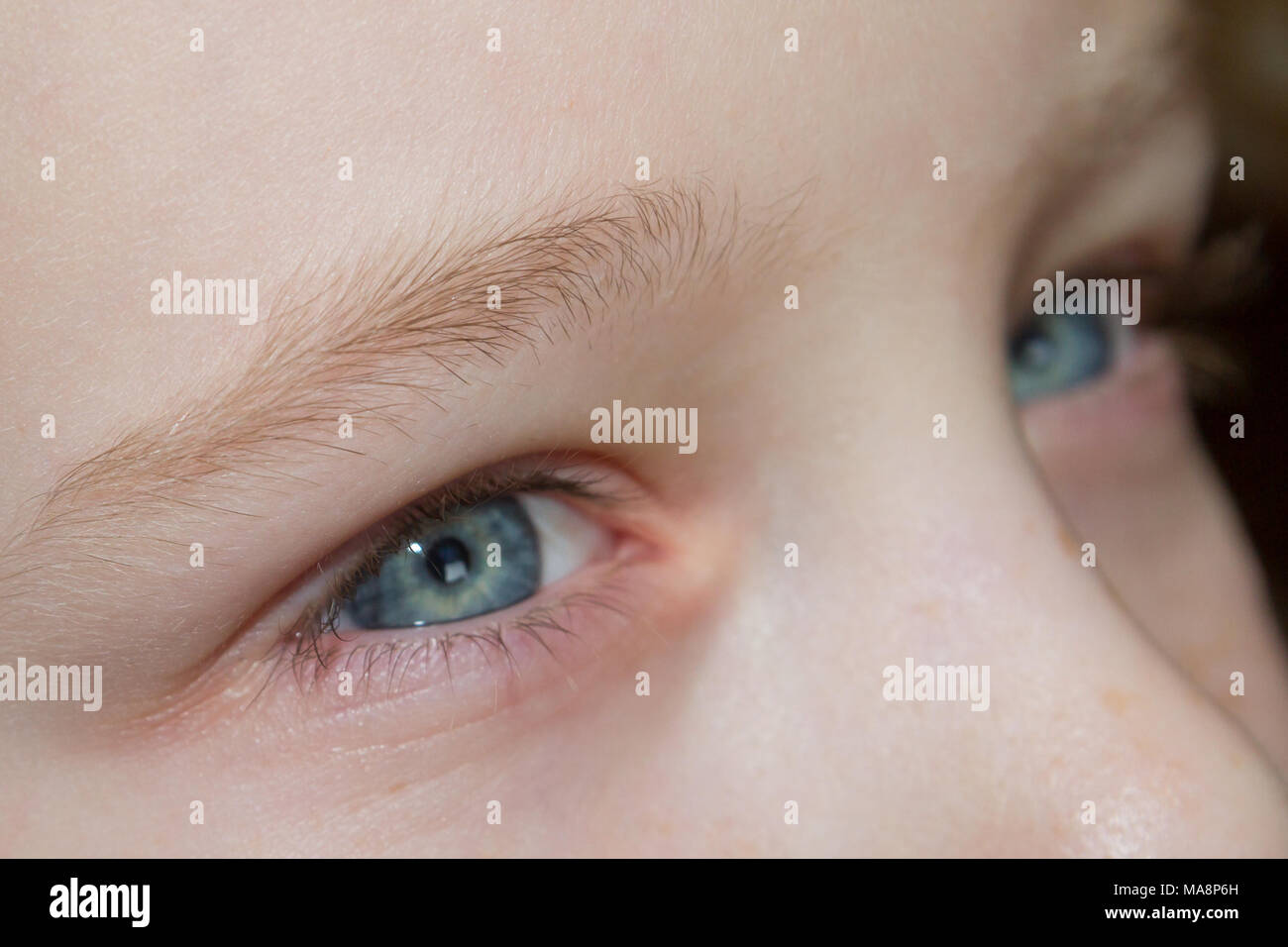 Baby blue beautiful, brooding eyes of a boy Stock Photo - Alamy