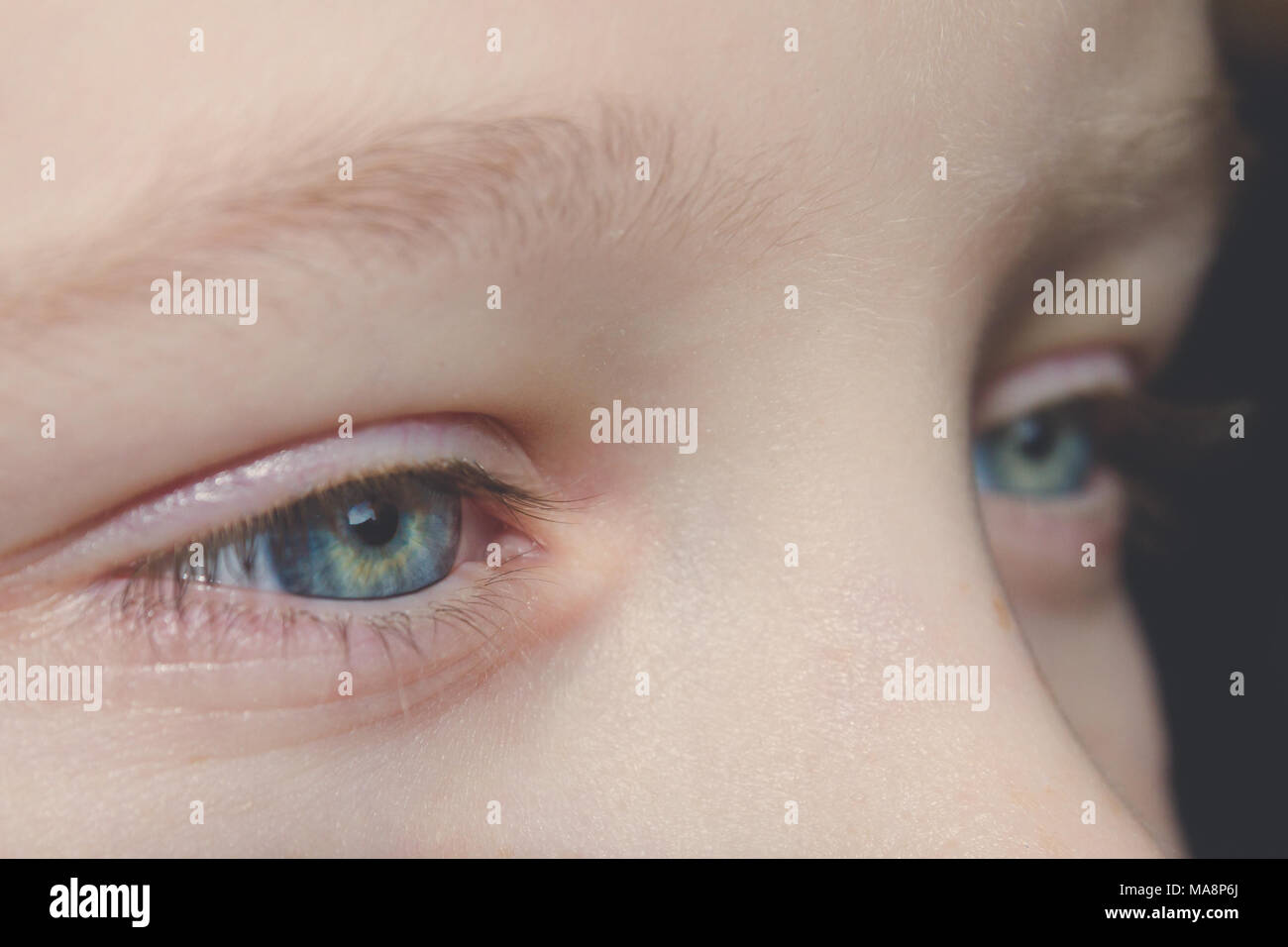 Baby blue beautiful, brooding eyes of a boy Stock Photo - Alamy