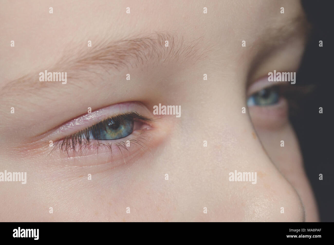 Baby blue beautiful, brooding eyes of a boy Stock Photo - Alamy