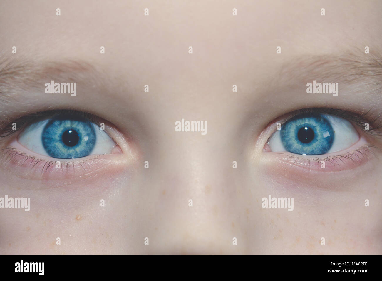 Baby blue beautiful, brooding eyes of a boy Stock Photo - Alamy