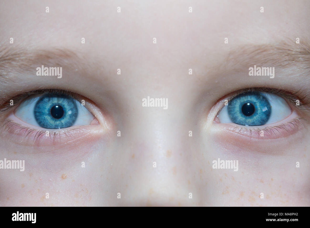 Baby blue beautiful, brooding eyes of a boy Stock Photo - Alamy