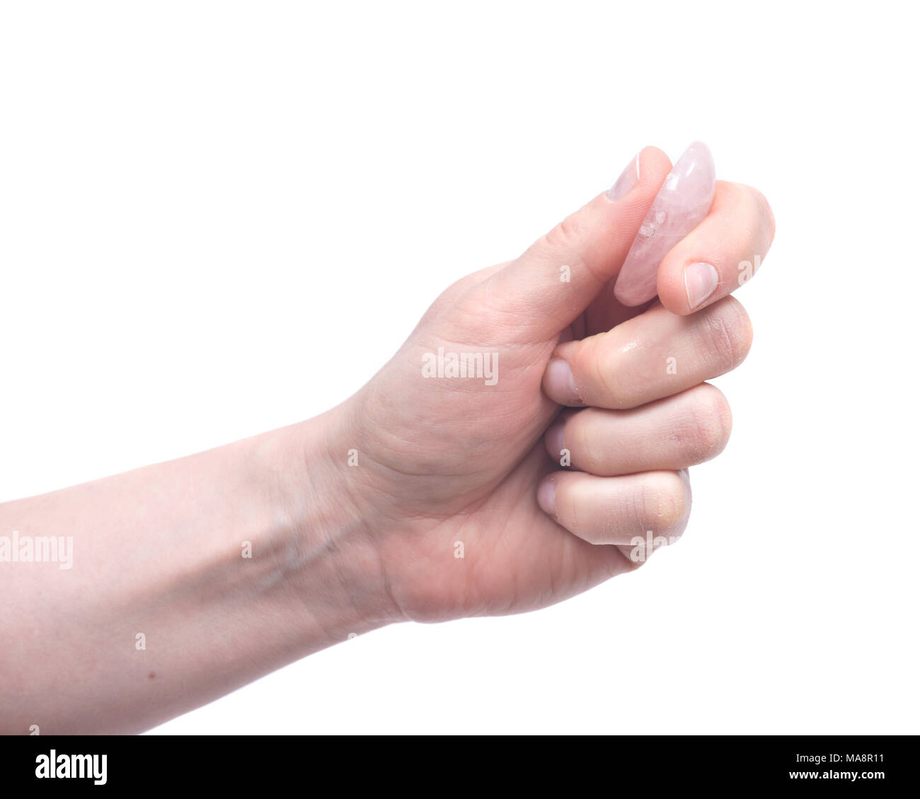 Young woman's hand holding rose quartz worry stone isolated on white ...