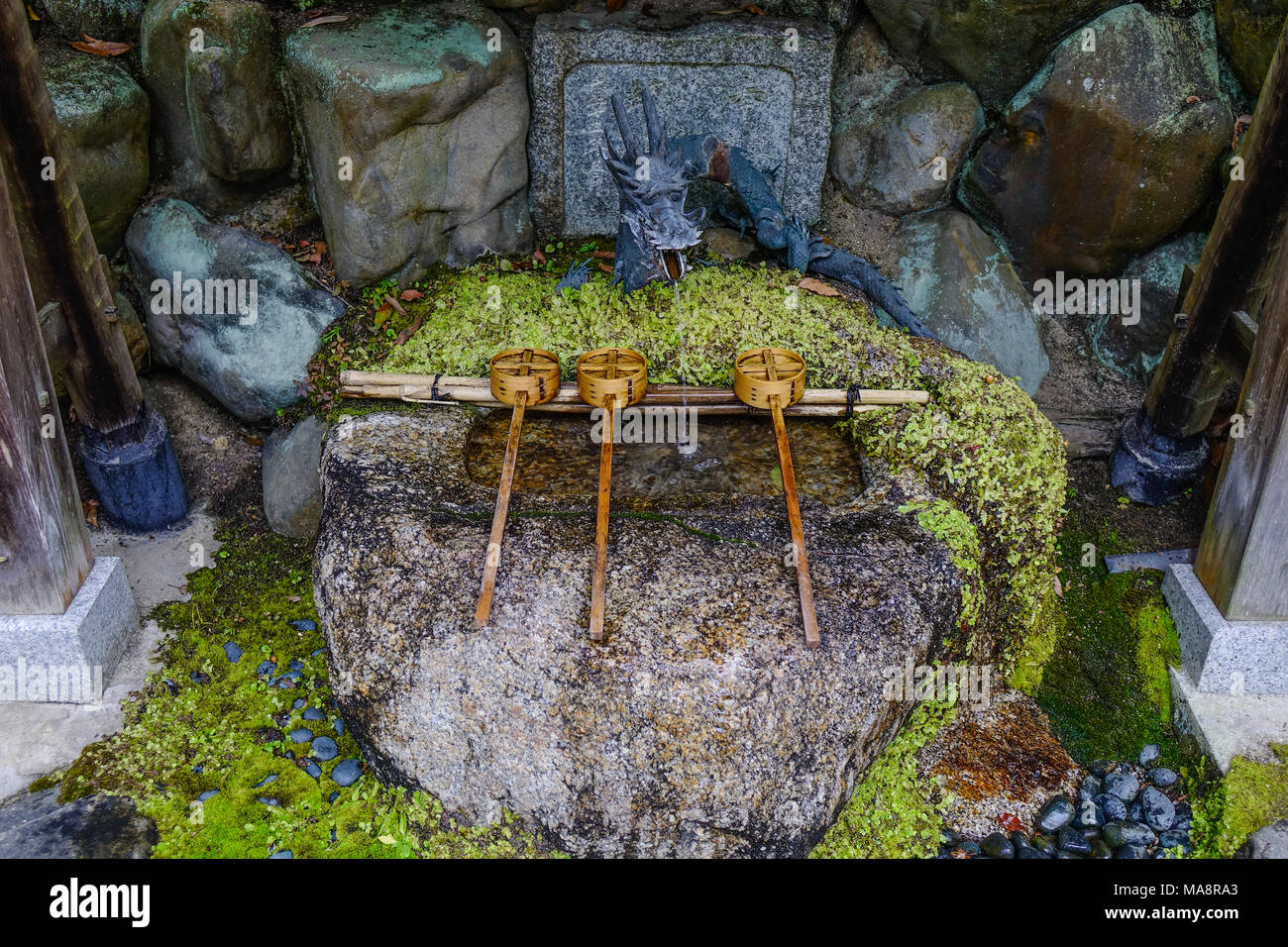 Japanese wooden ladles at Shinto temple in Kyoto Japan. In Japan a ...