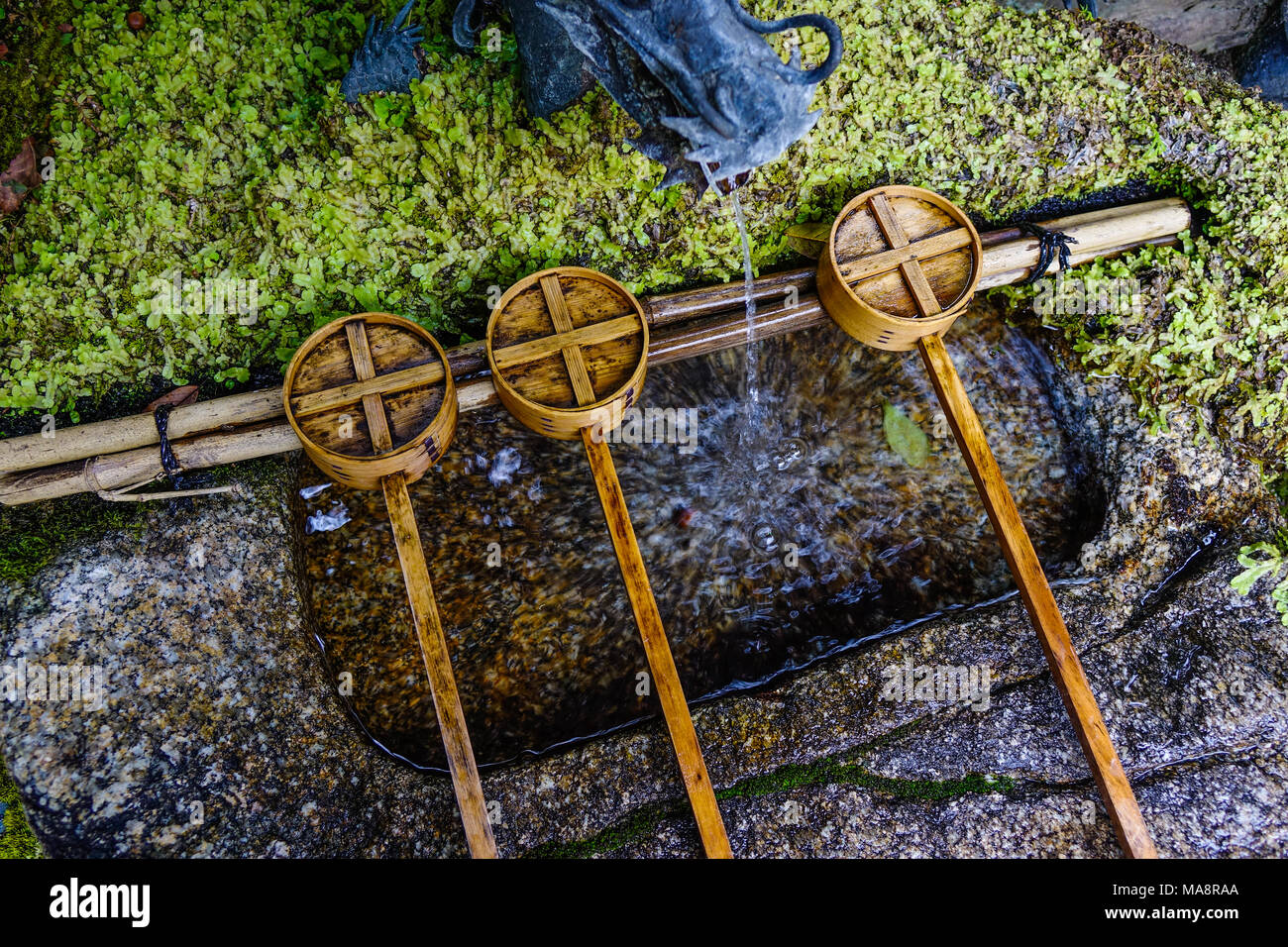 Japanese wooden ladles at Shinto temple in Kyoto Japan. In Japan a ...