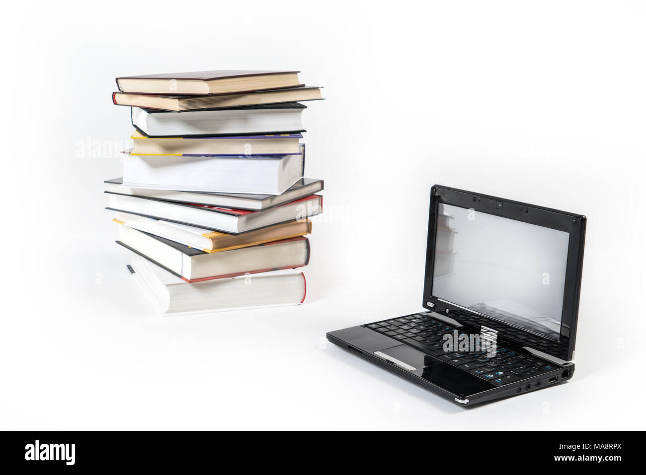 Stack of book and laptop isolated on white Stock Photo - Alamy