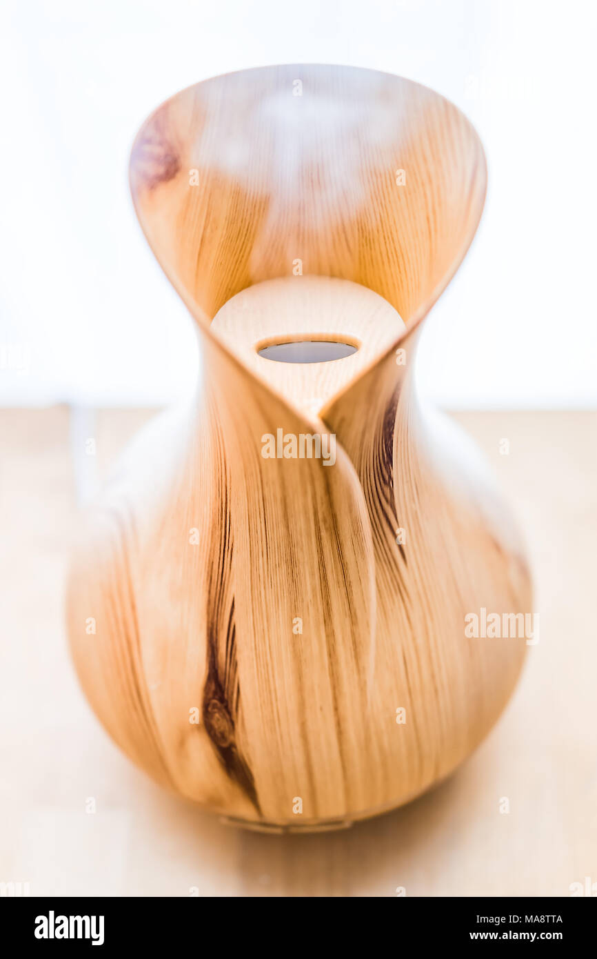 Wooden bamboo essential oil diffuser closeup, with steam, cable modern ...