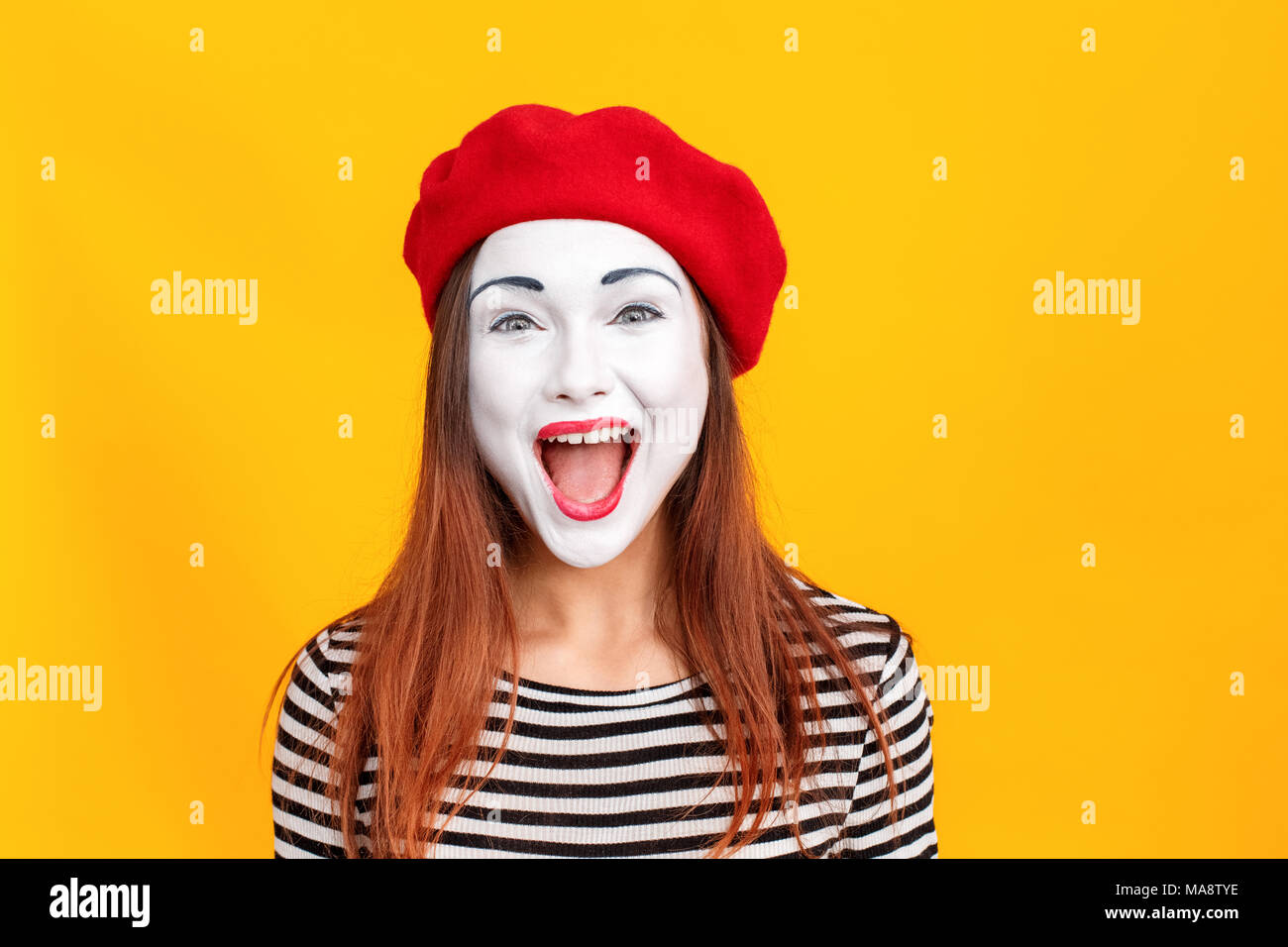 Closeup portrait of toothy smiling mime woman in striped jacket ...