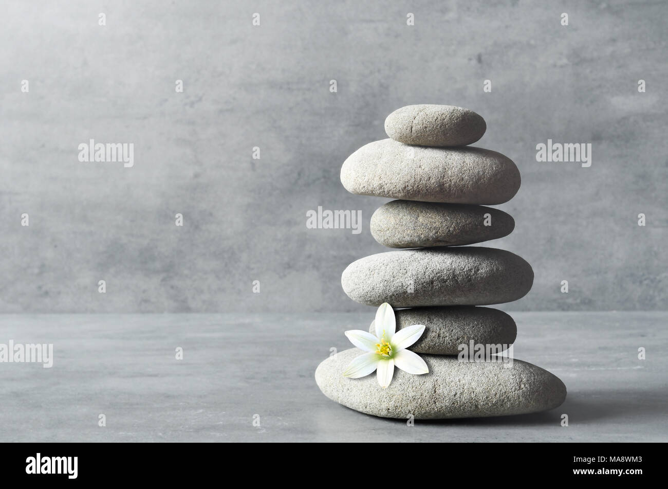 Stones and white flower balance. Zen and spa concept Stock Photo - Alamy