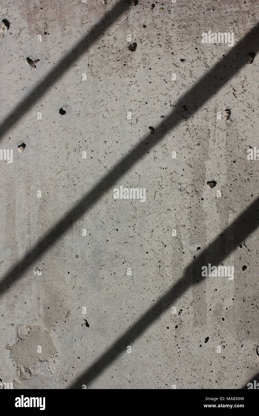 Modern concrete wall with three diagonal steel code shadows tightly ...