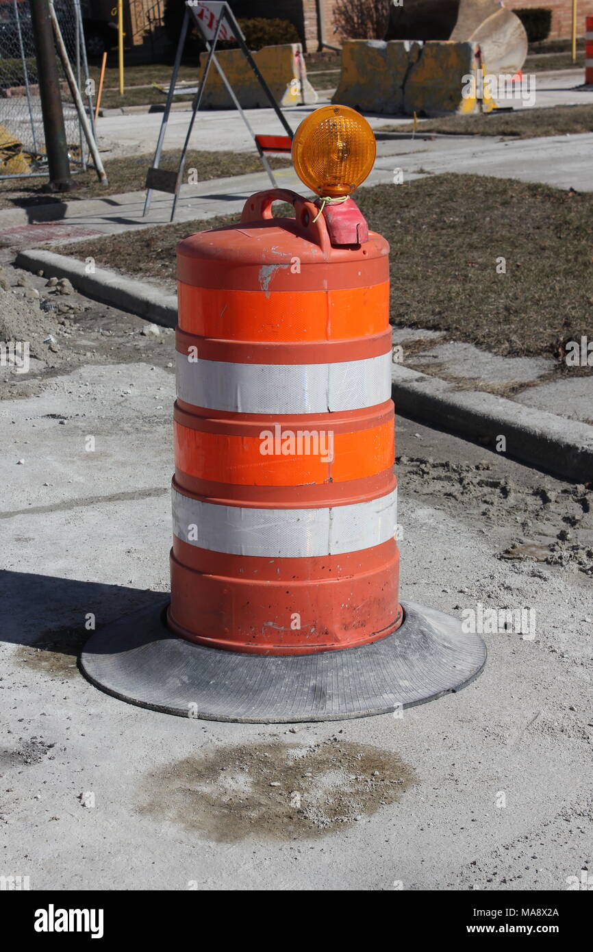 Full view of a construction traffic barrier with bright orange and ...