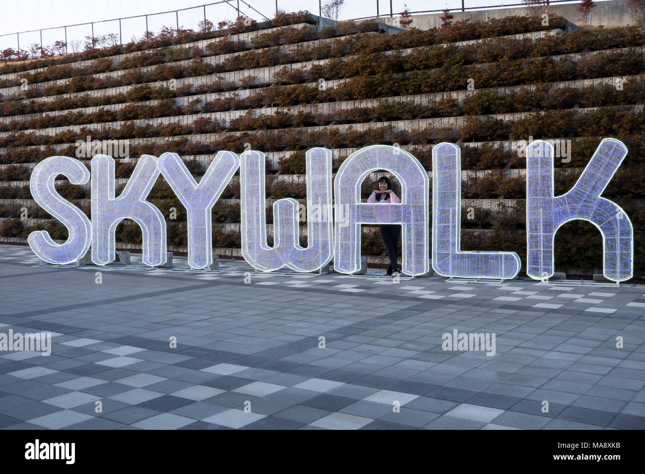 Female traveller taking a photo of the Skywalk letters at the Mishima ...