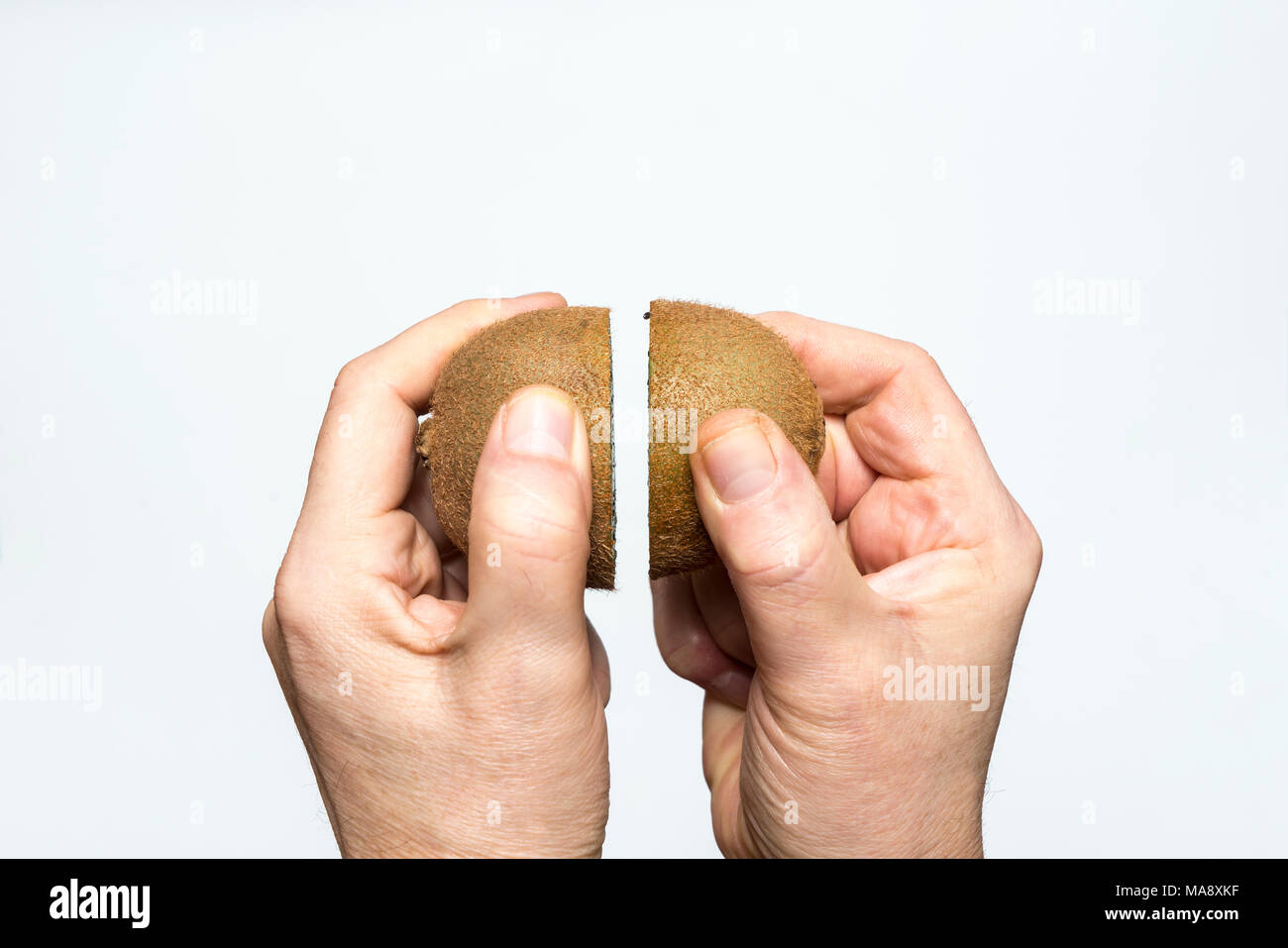 A kiwi cut in a hand Stock Photo - Alamy
