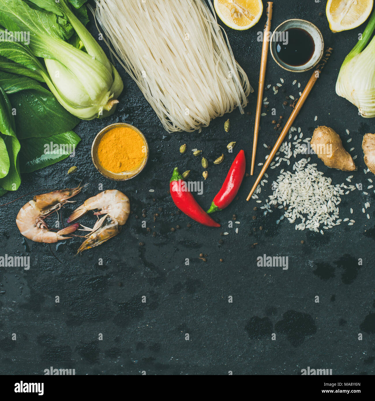 Asian cuisine ingredients over dark slate stone background, square crop ...